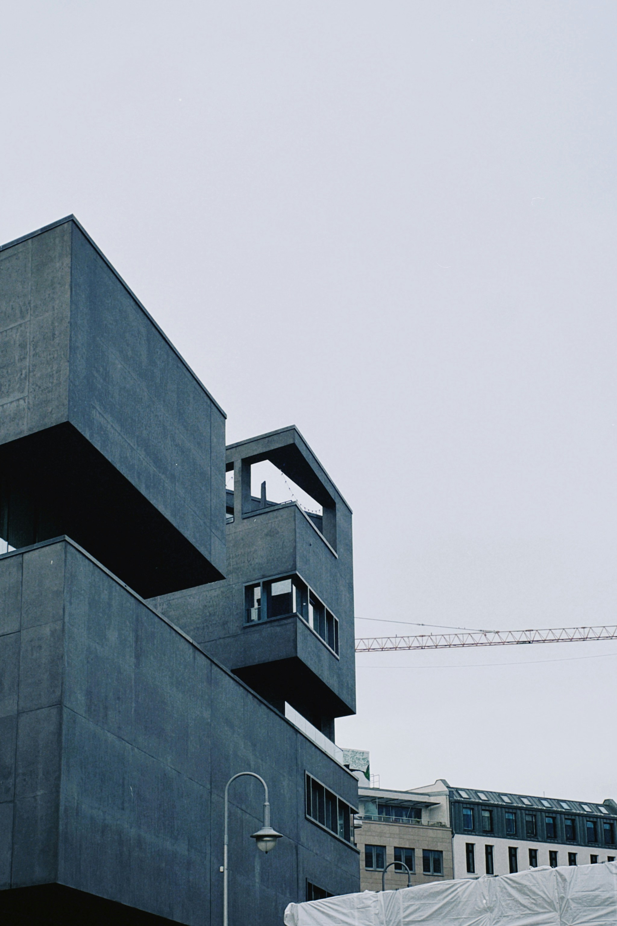 Concrete Geometry: A Brutalist Corner Rising Against a Pale Sky
