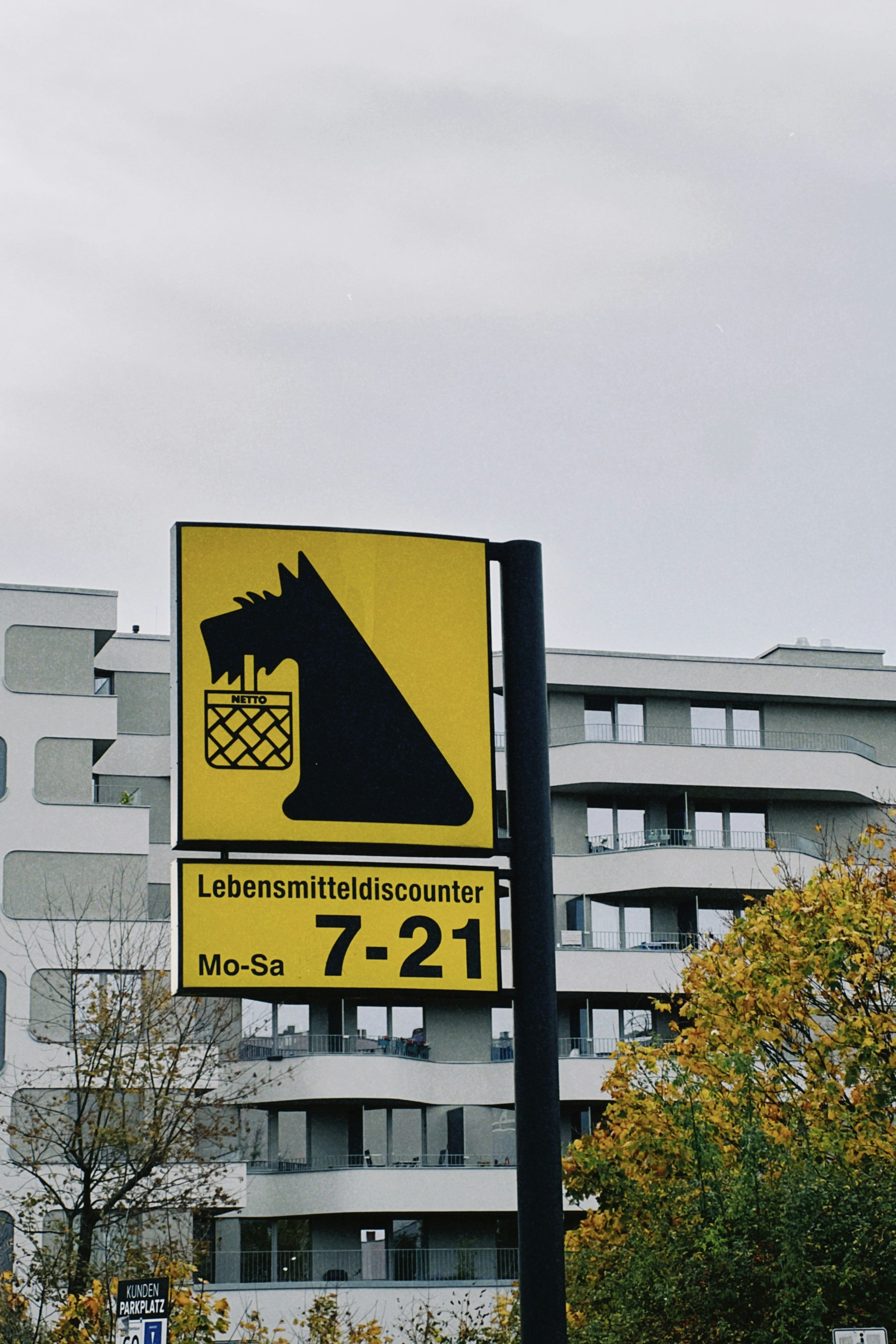 a yellow sign on a pole