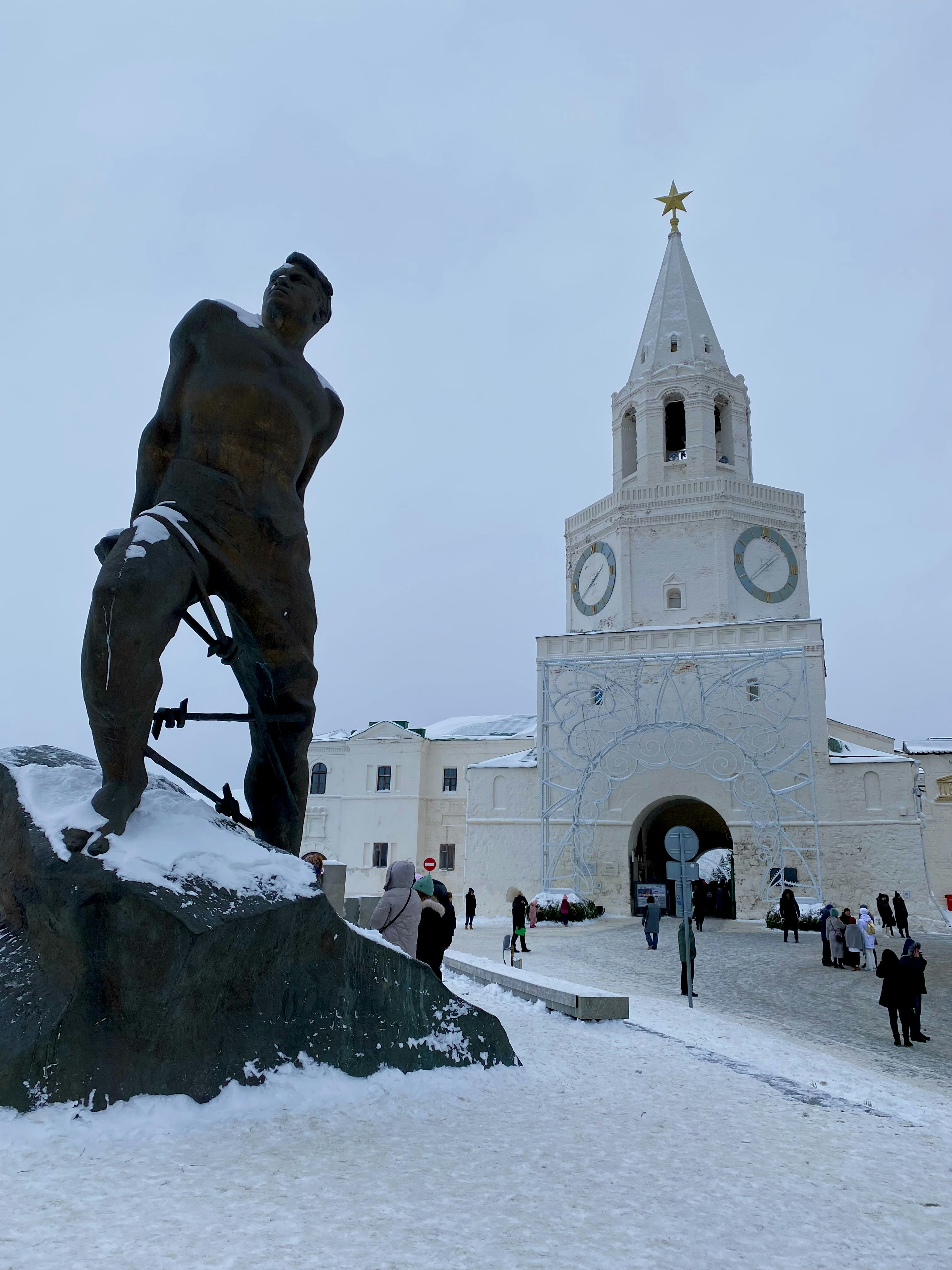 Statue of a Braced Figure with Snow-Cwept Gatehouse