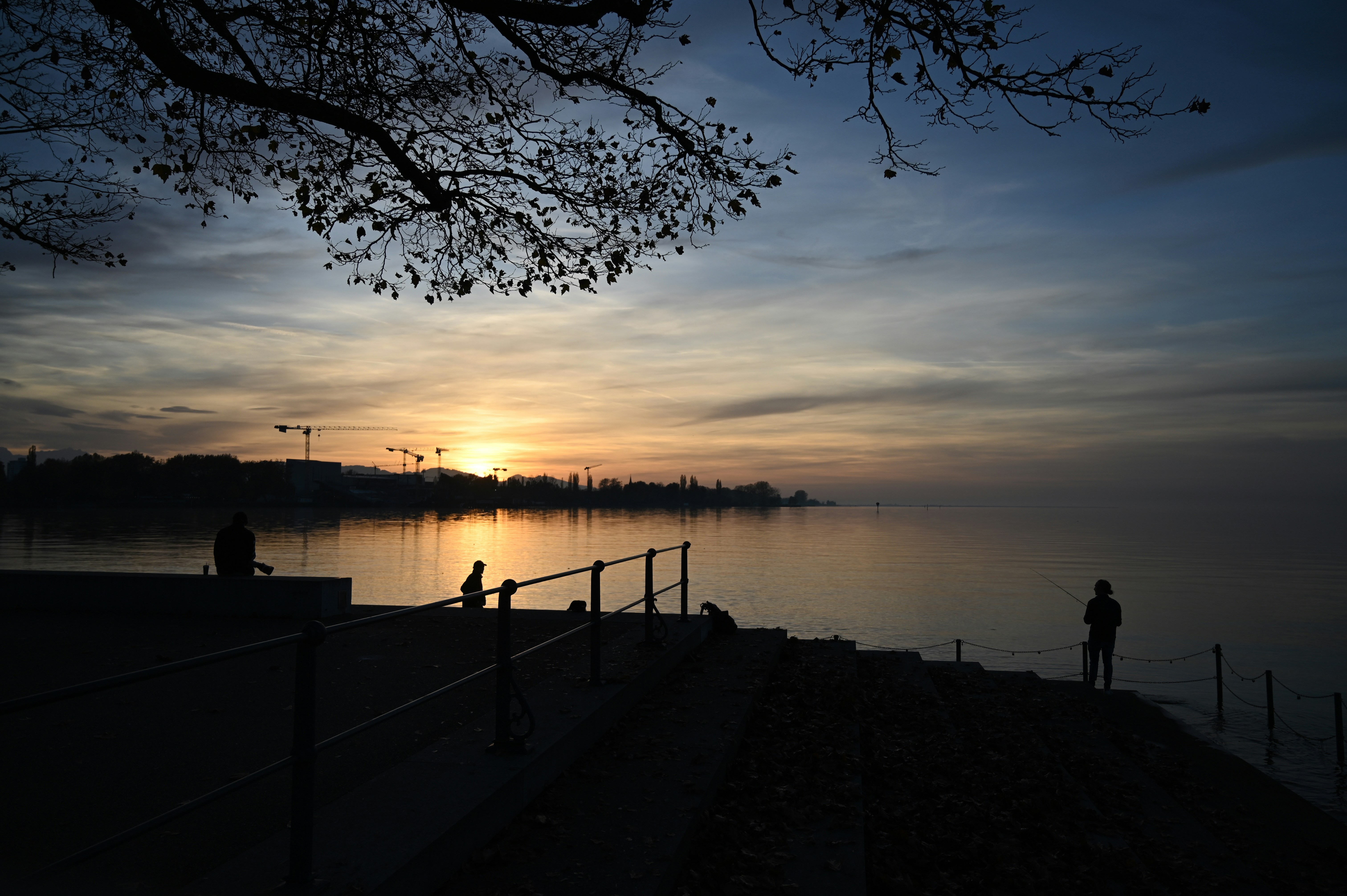A group of people standing on a dock by a body of water photo – Free ...