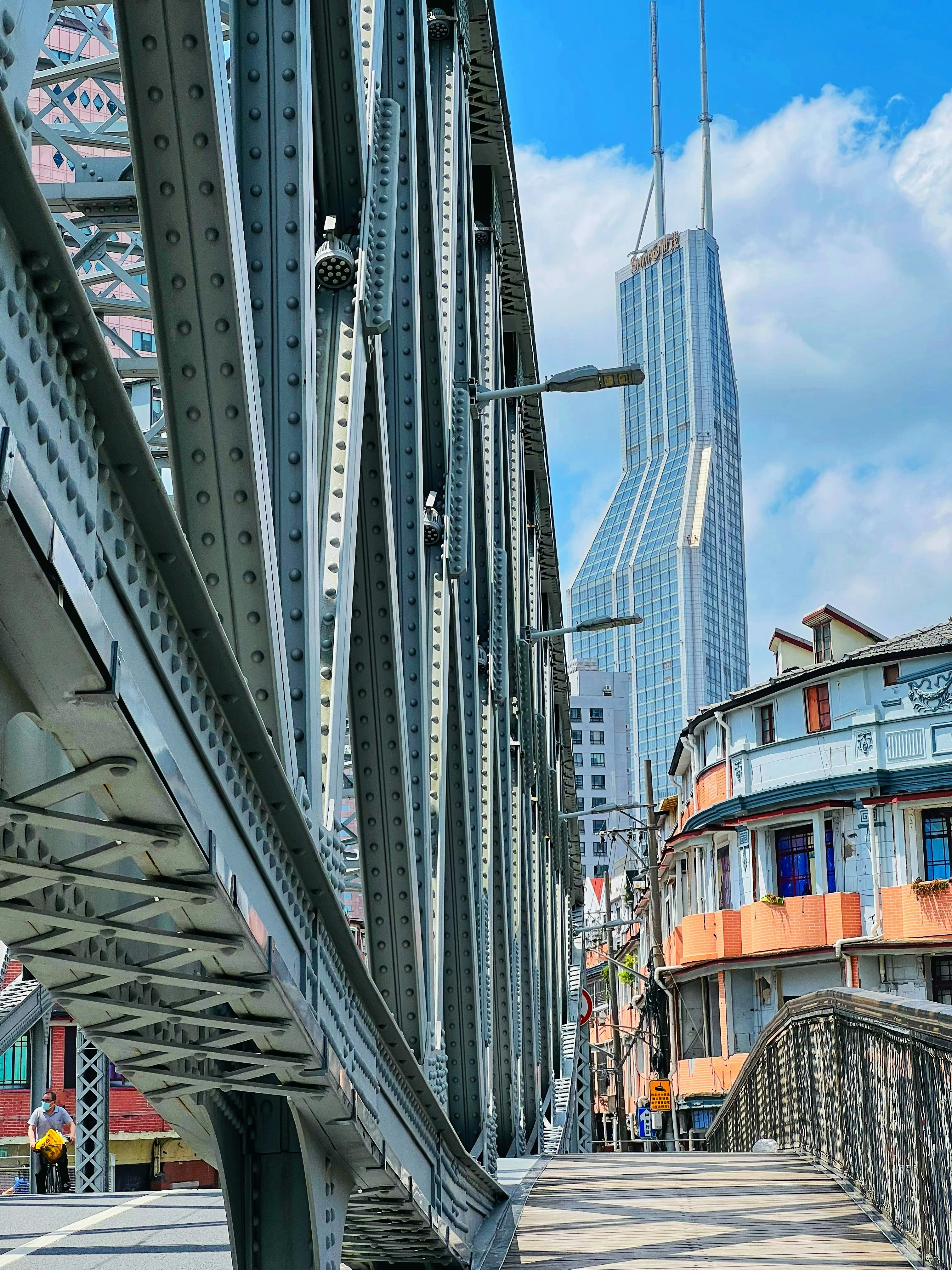 A bridge with a tall building in the background photo – Free Bridge ...