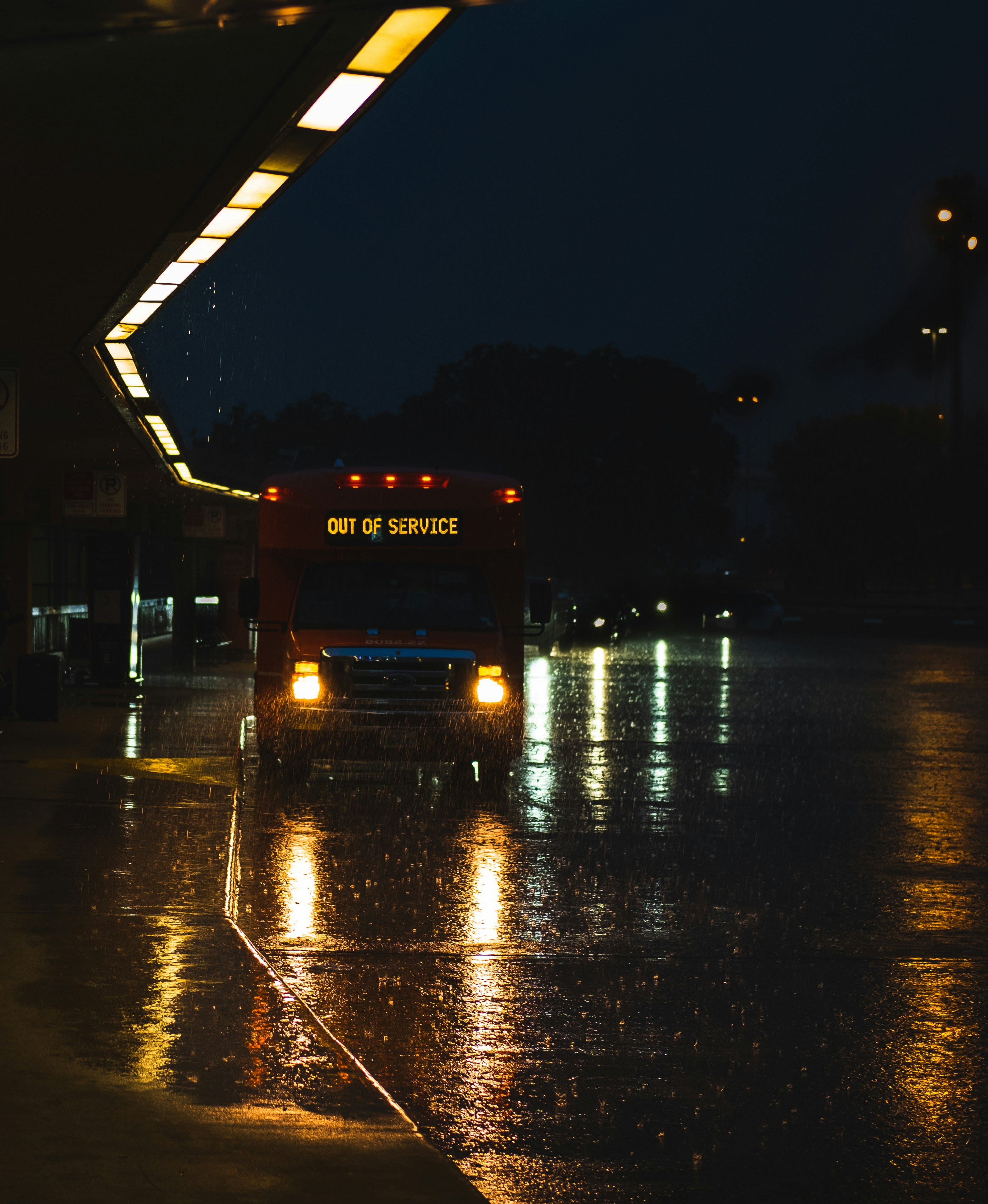 a bus driving down a wet street