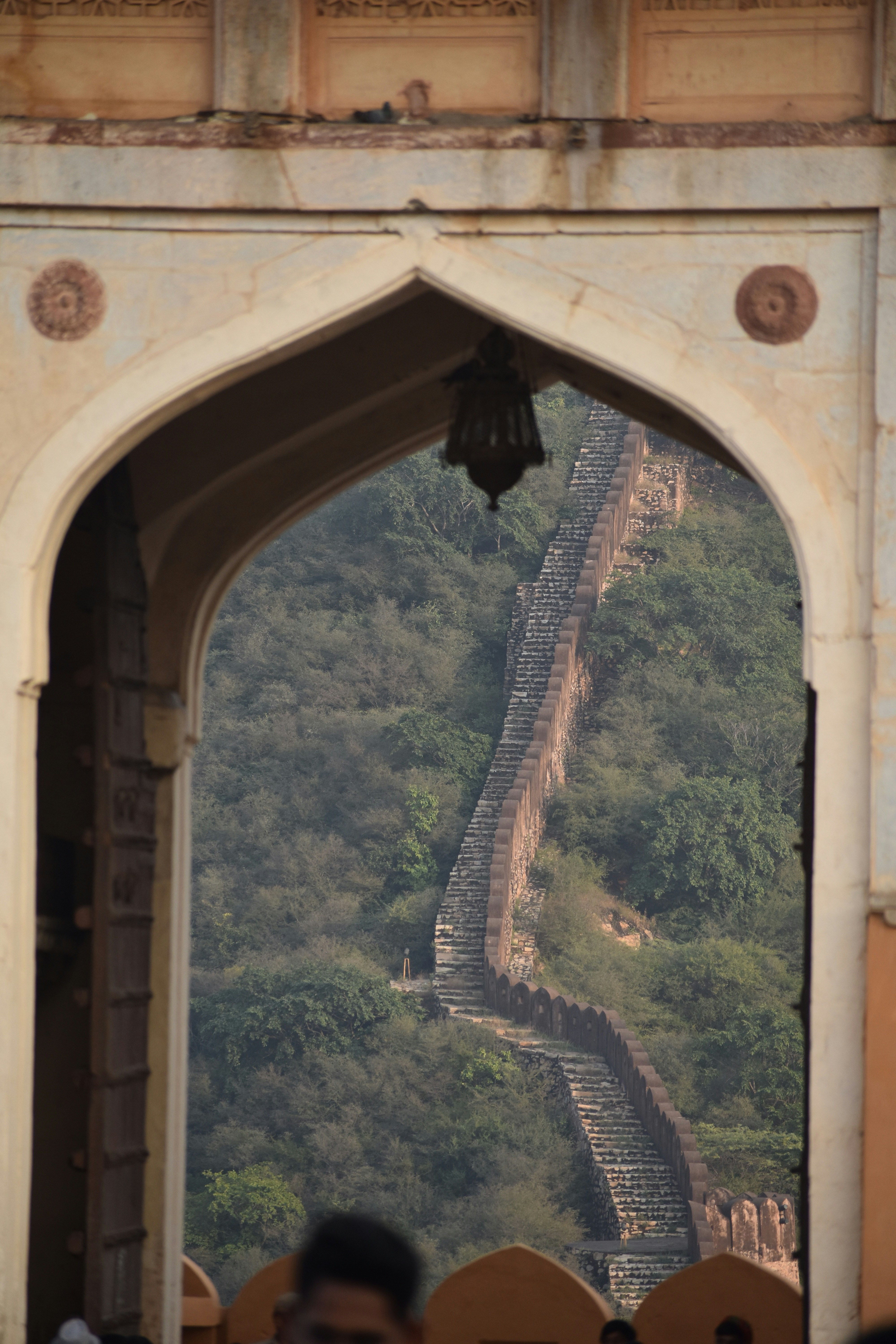 Through the Arch: Serpentine Staircase Winding into the Hills
