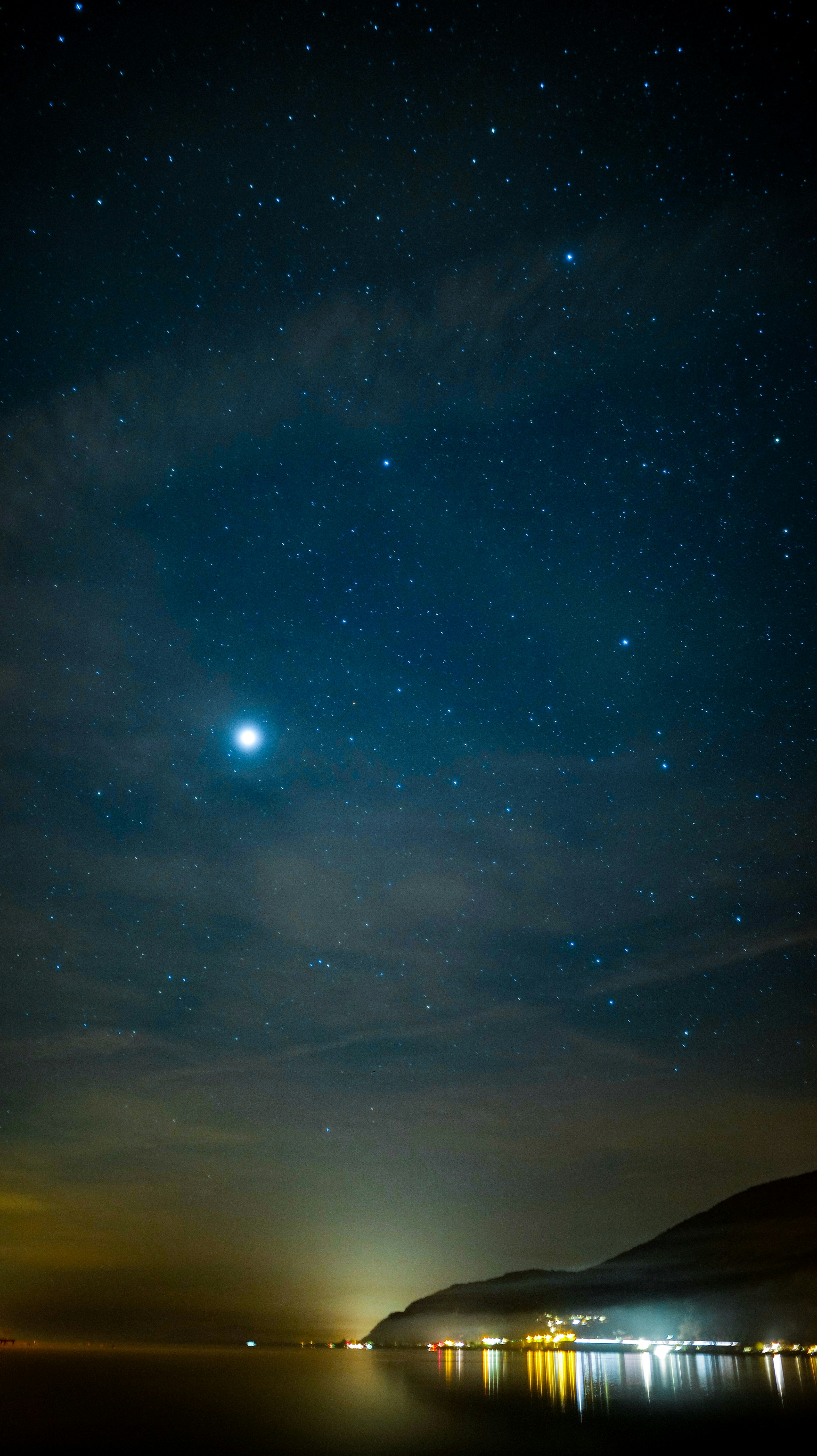 Starfield over a Quiet Fjord: Harbor Lights Mirror the Night