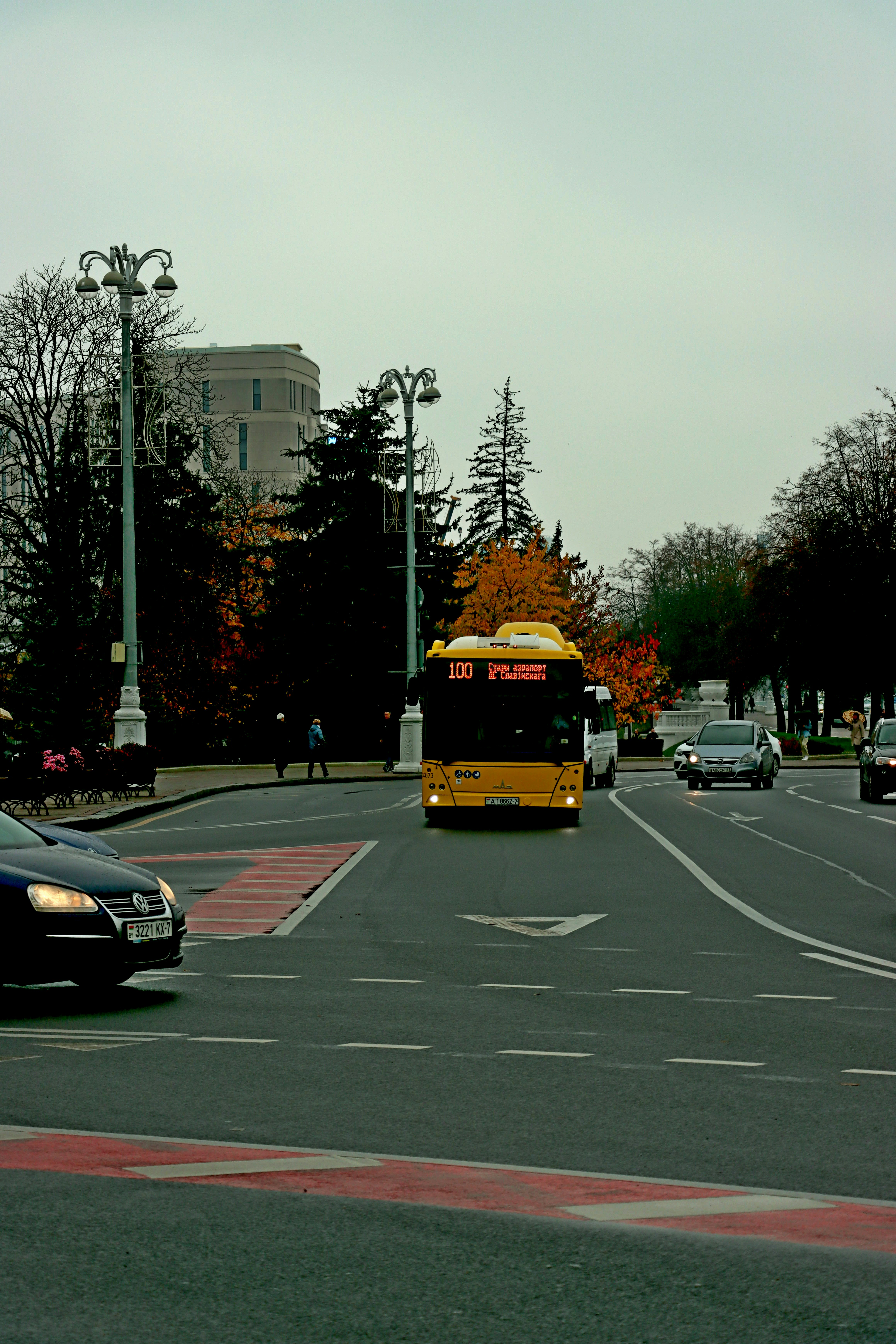 a yellow bus driving down a street