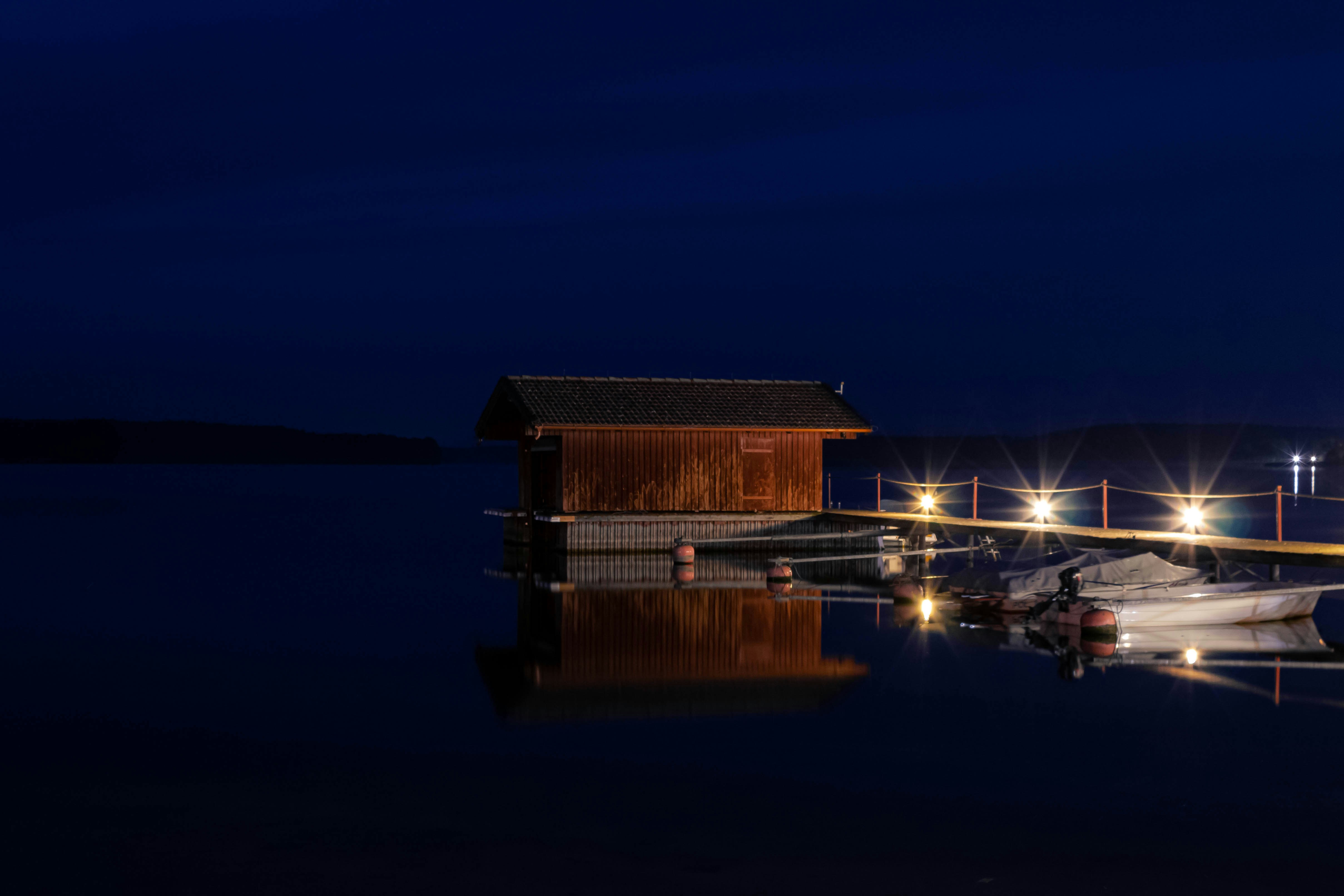 Solitary Boathouse Under Midnight Blue