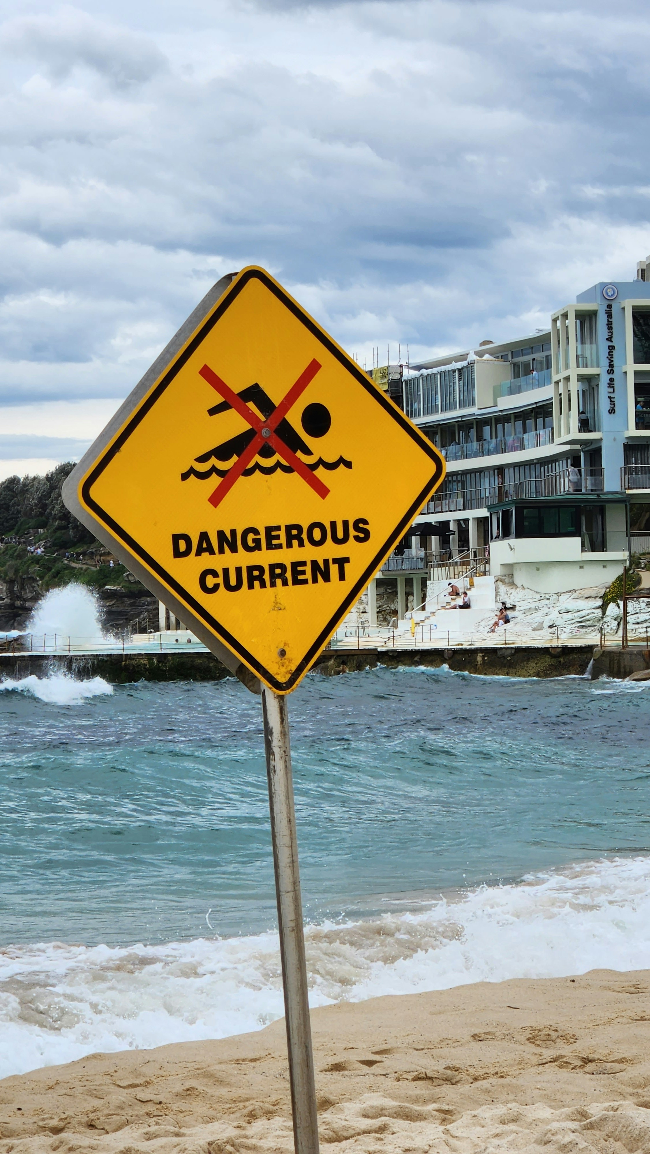 A yellow sign on a beach photo – Free Bondi beach nsw Image on Unsplash