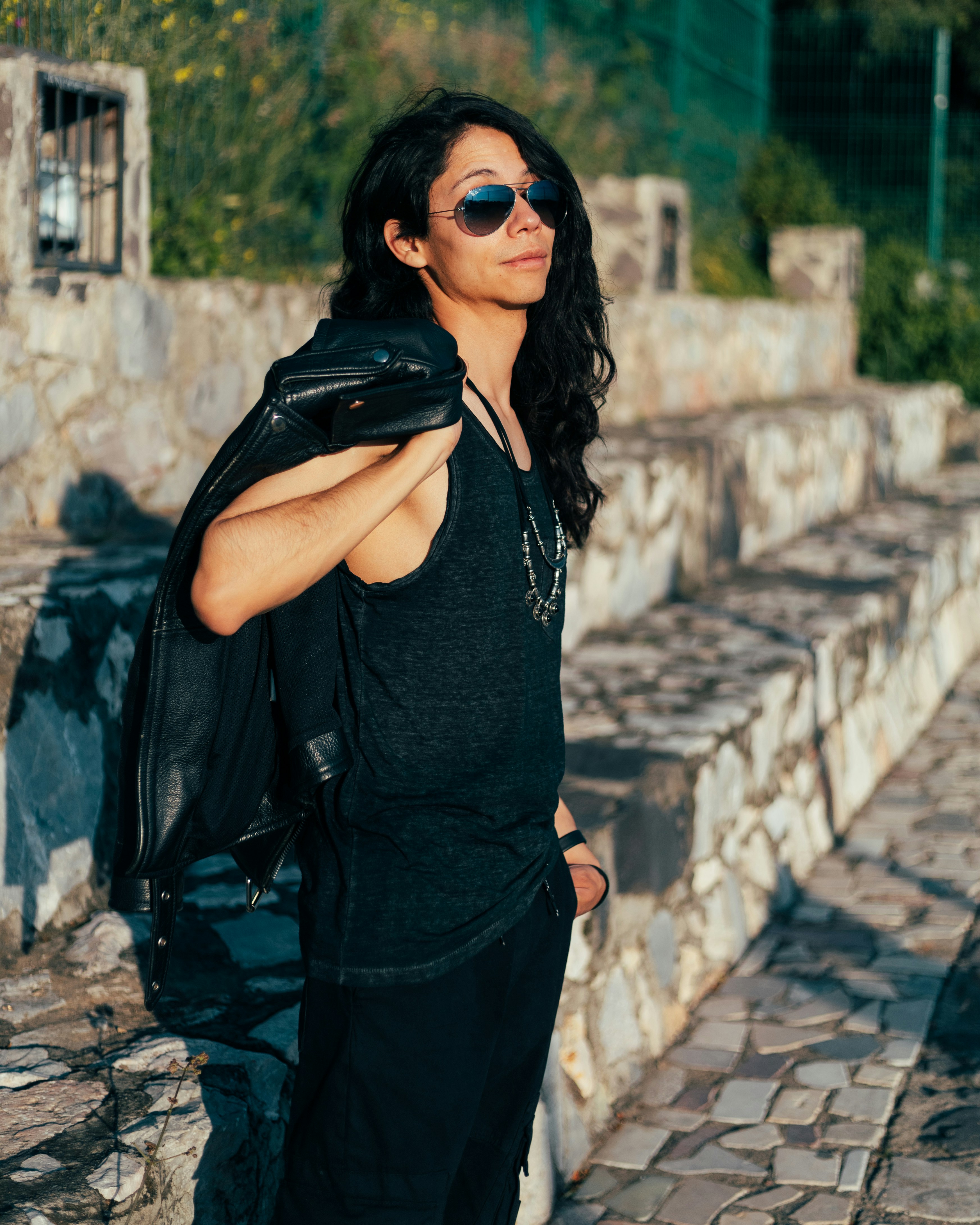 Shadow and Steel on Weathered Steps: A Quiet Portrait of a Traveler