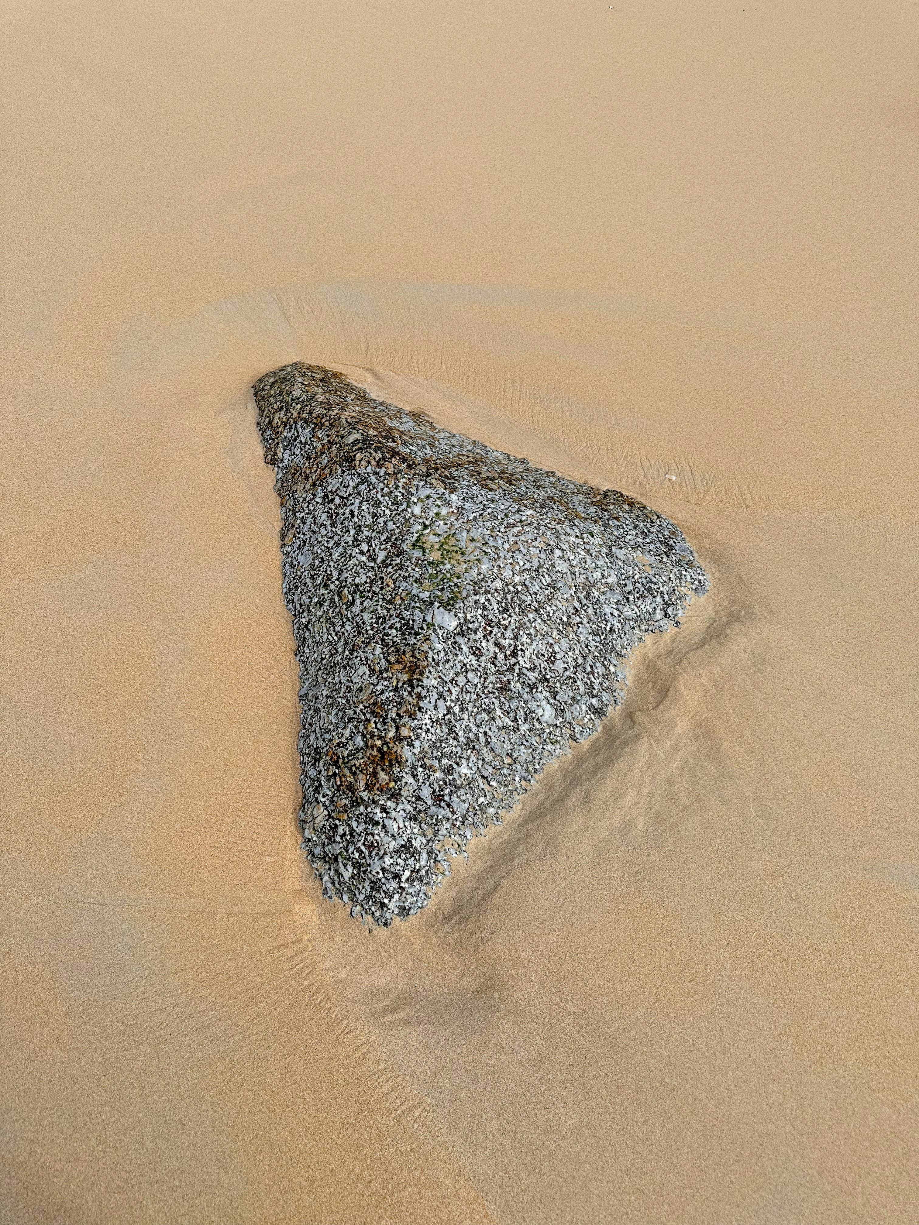 Triangular Rock Emerges from a Sea of Dune Ripples