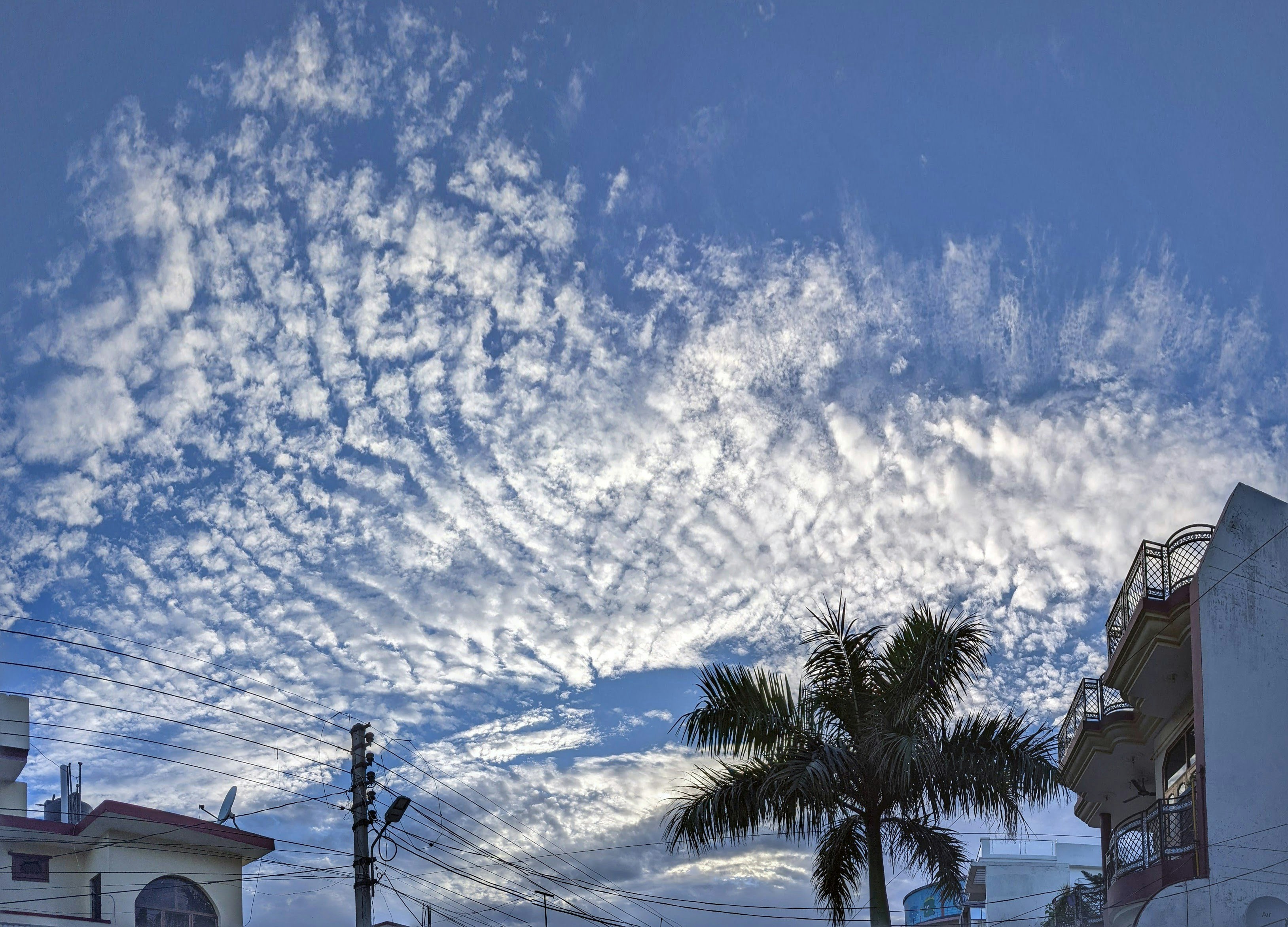 Cotton-Cloud Sky Over Urban Rooftops