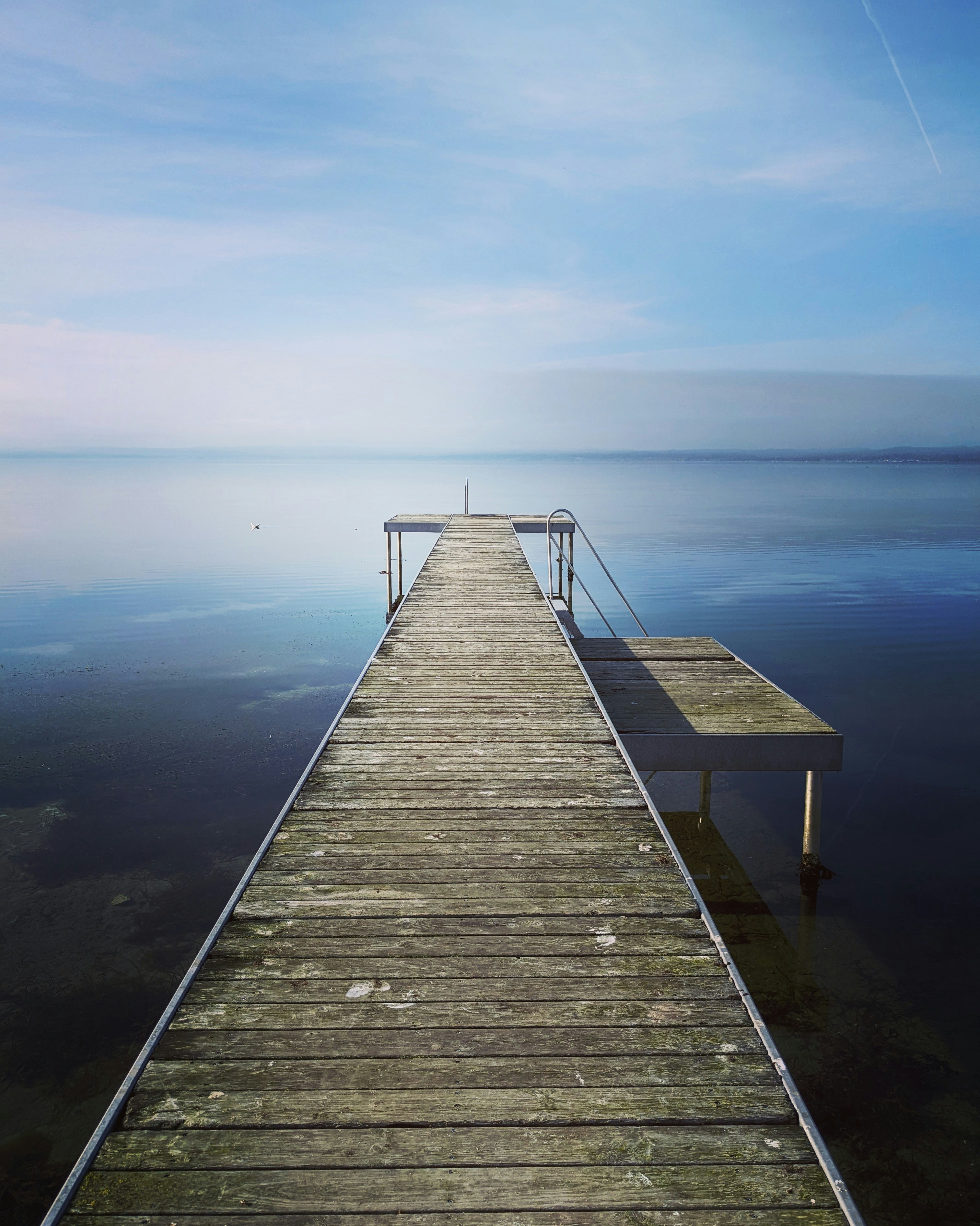 A wooden dock over water photo – Free Ocean view Image on Unsplash