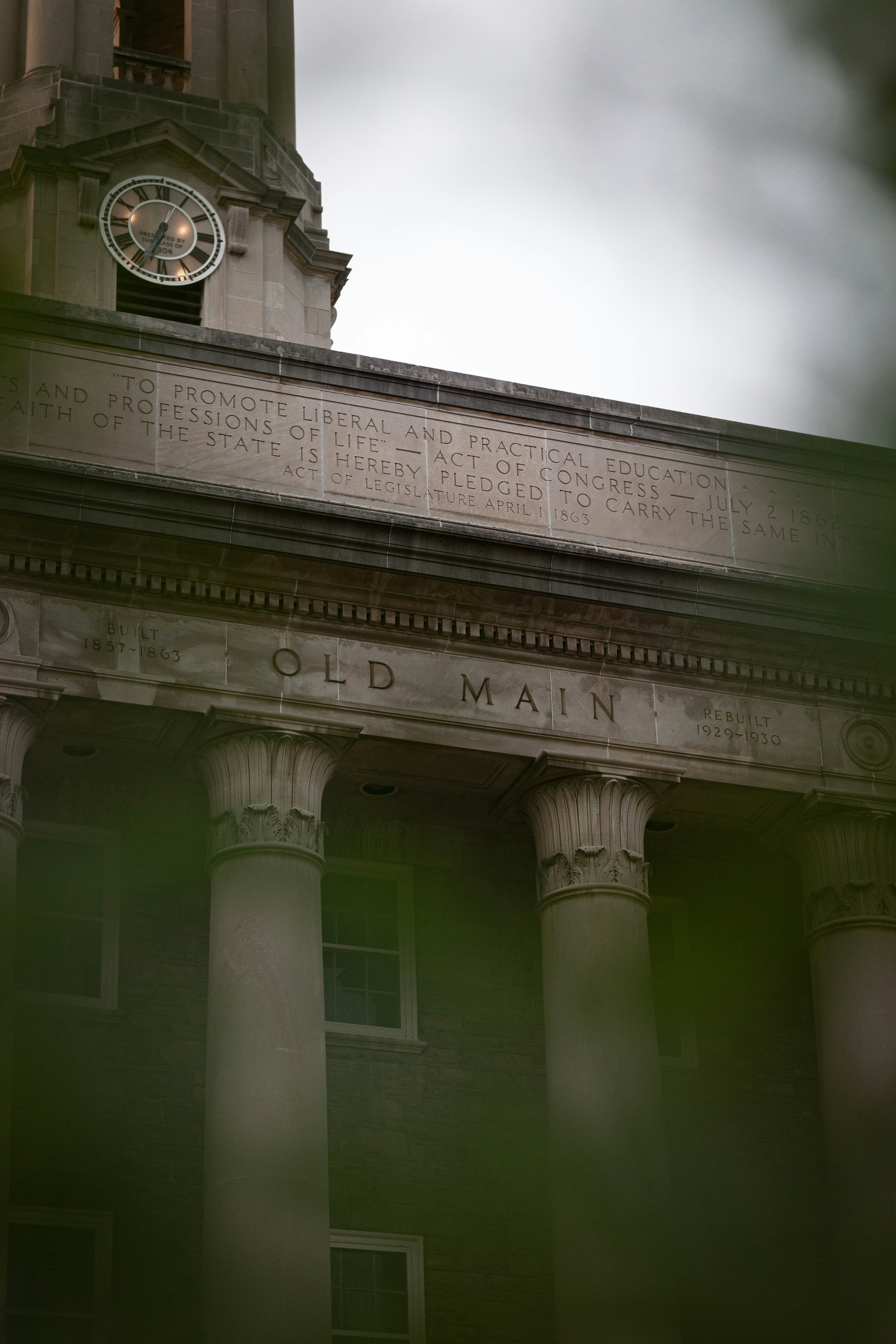 Old Main’s Gentle Gaze through a Veil of Green