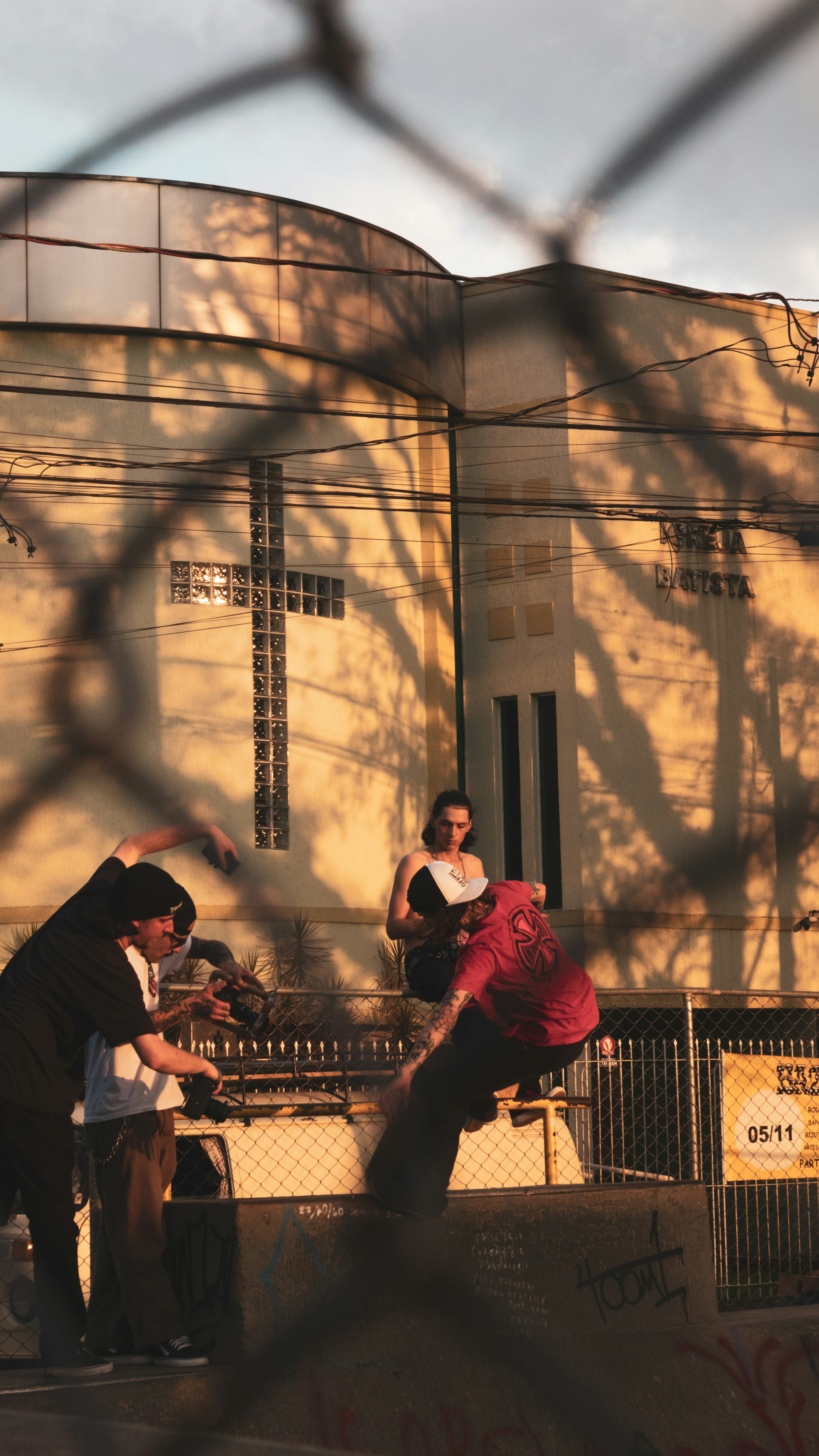 Shadowed Rings: Roller Playground Behind a Chain-Link Veil