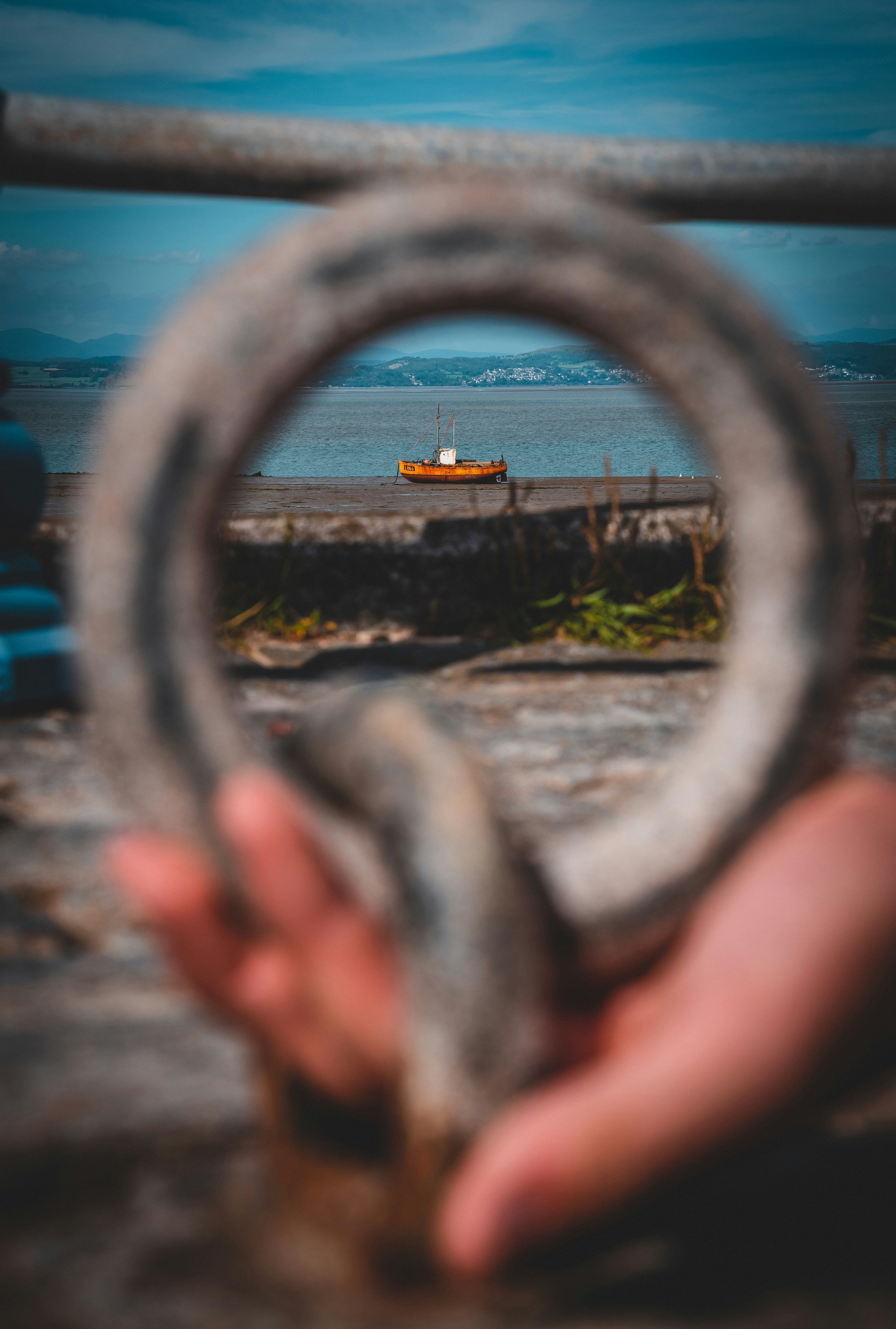 a hand holding a steering wheel