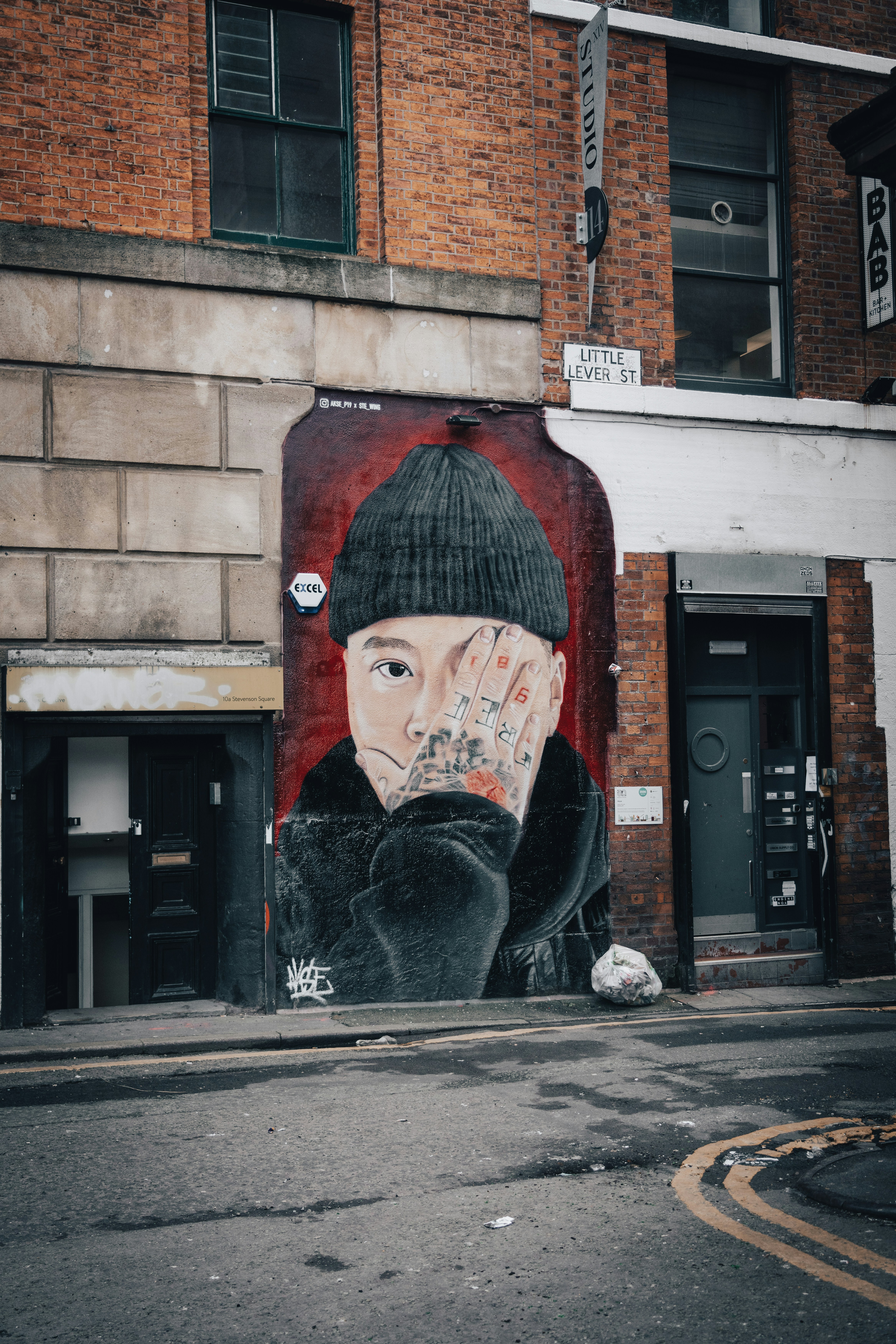 Crimson Doorway Portrait: Gaze in a City Mural