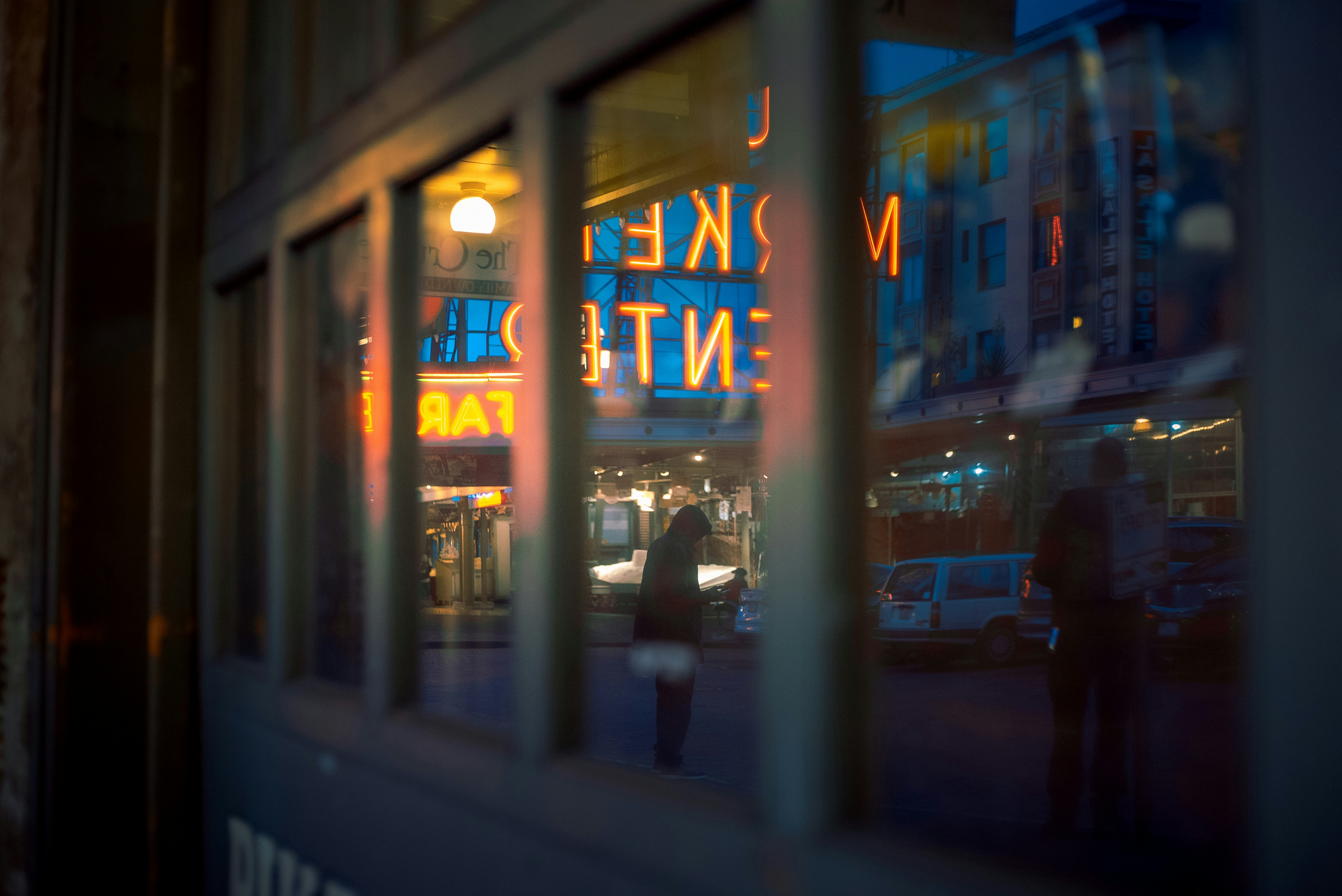 A person walking in front of a storefront photo – Free Seattle Image on ...