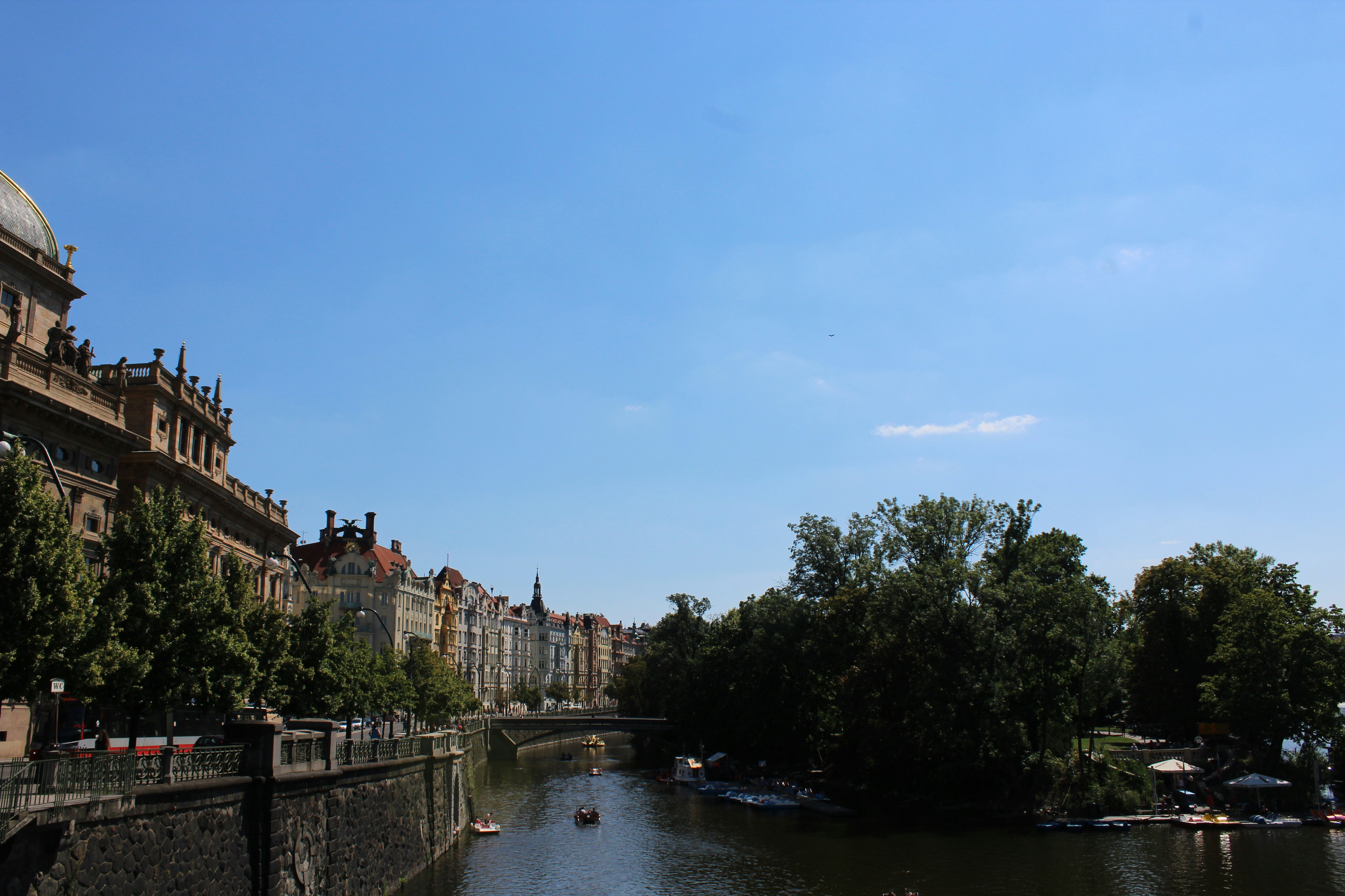 A river with a bridge and buildings along it photo – Free Chequia Image ...