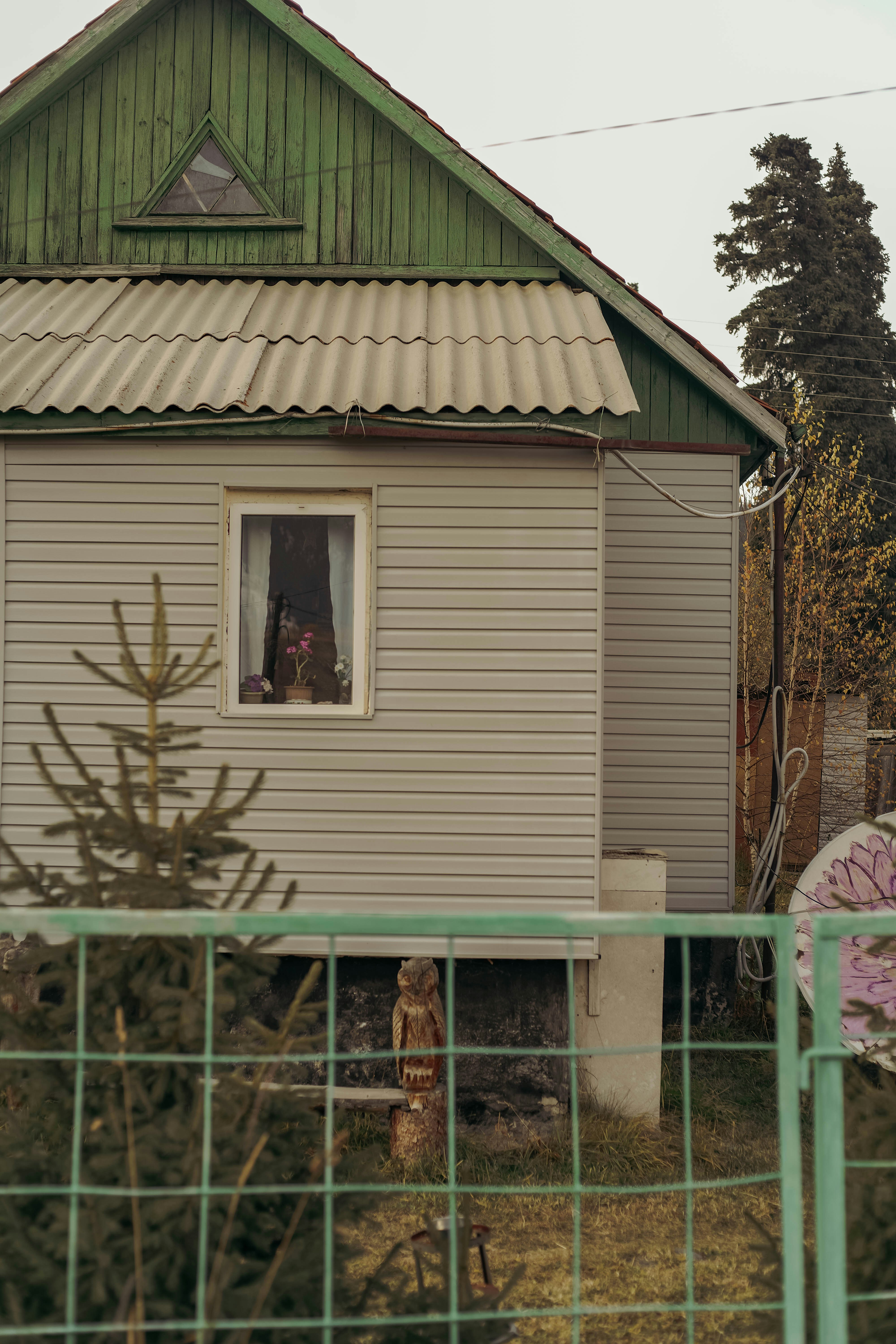Quiet House Corner with Metallic Fence and Green Gable