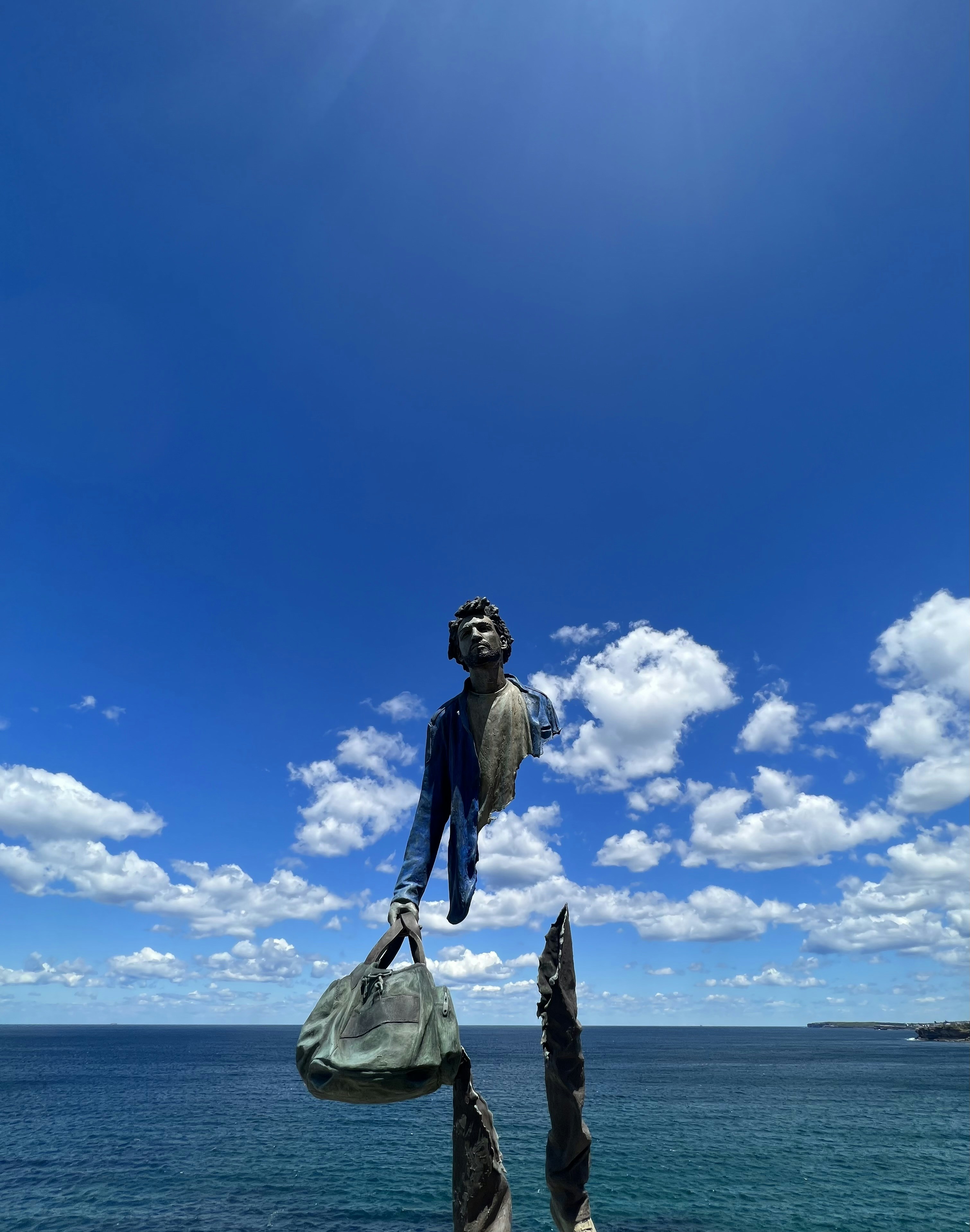 Skyward Bust Above the Sea: A Surreal Seaside Sculpture