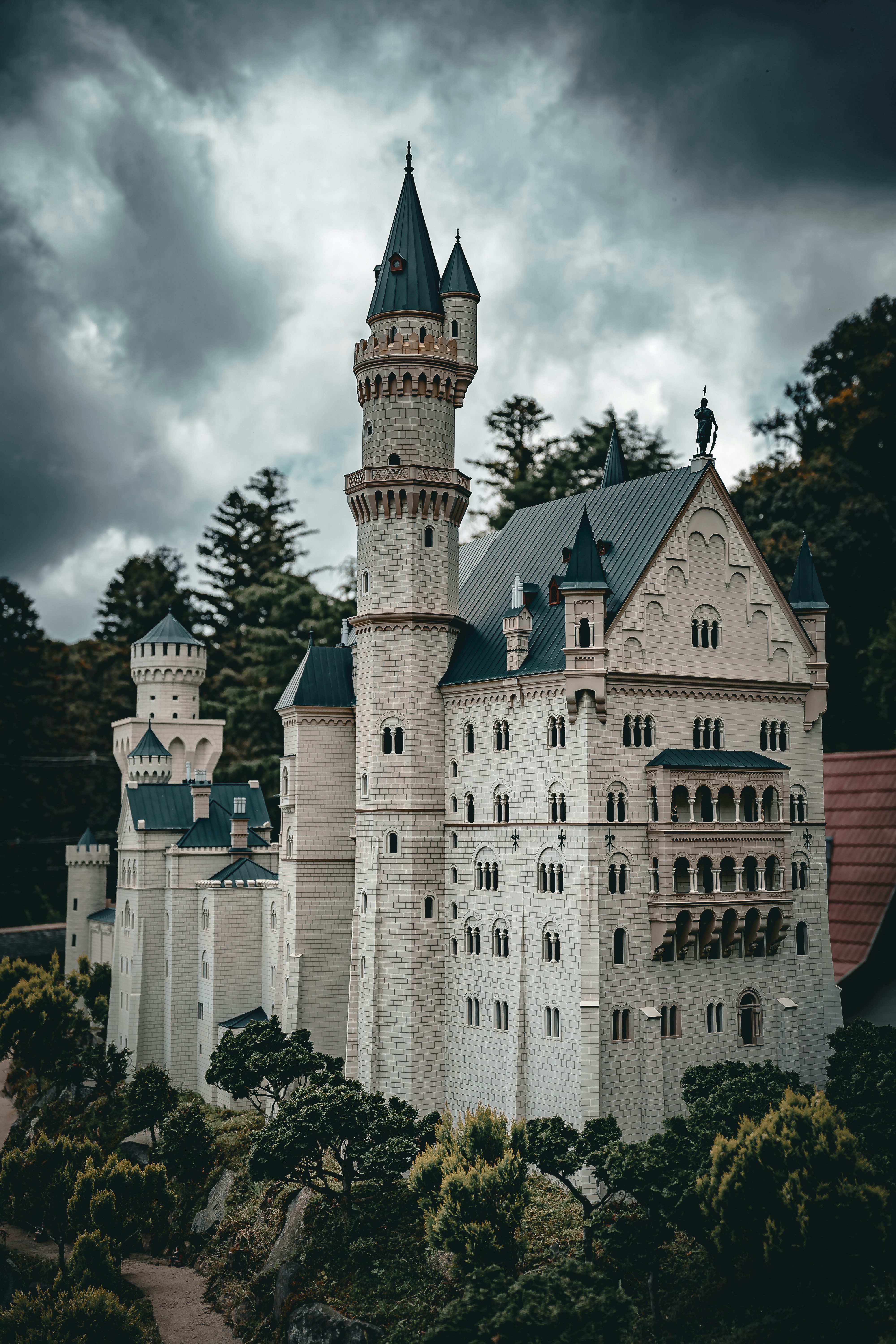 A large white castle with Neuschwanstein Castle in the background photo ...
