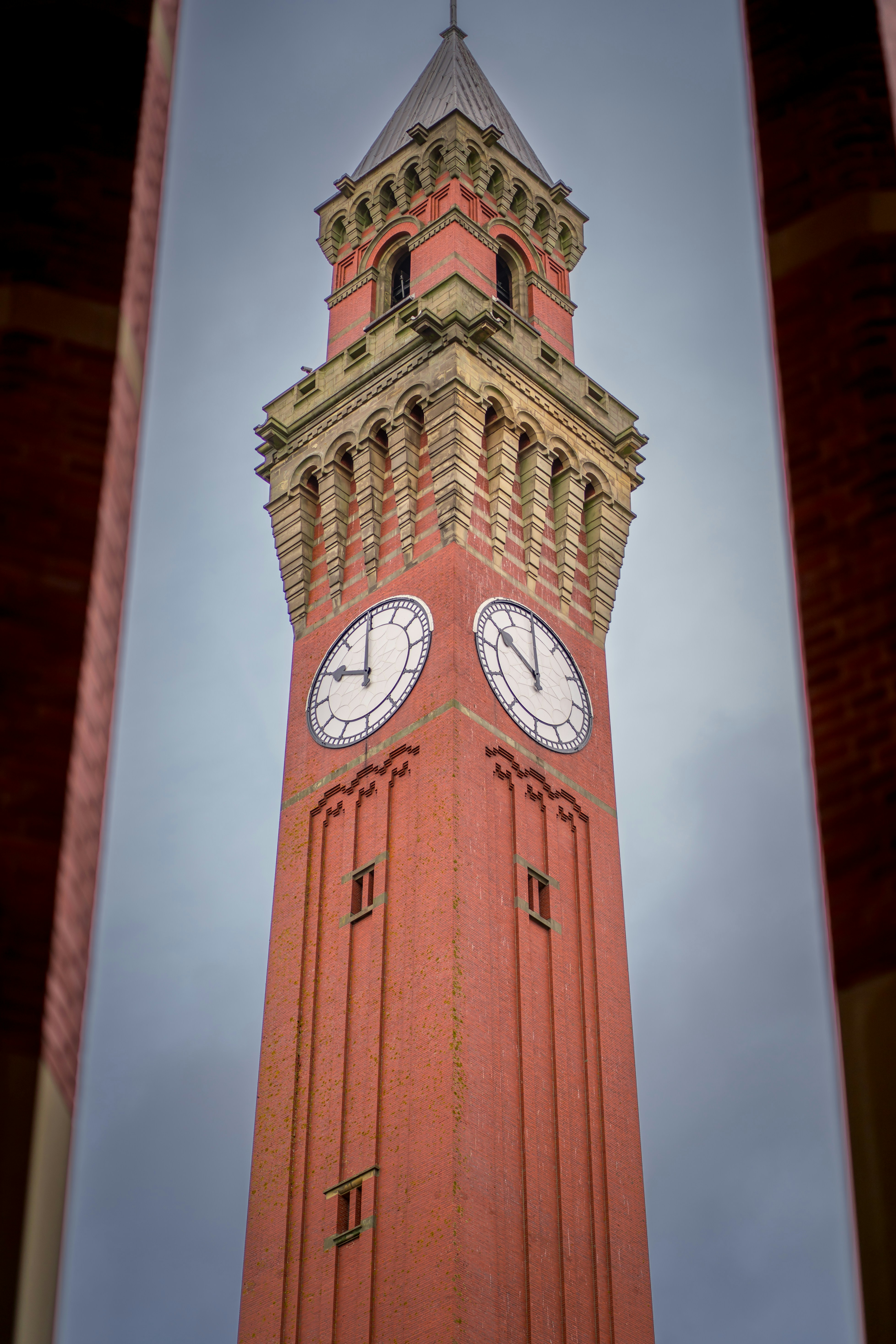 Red Brick Clock Tower Framed Between Archways