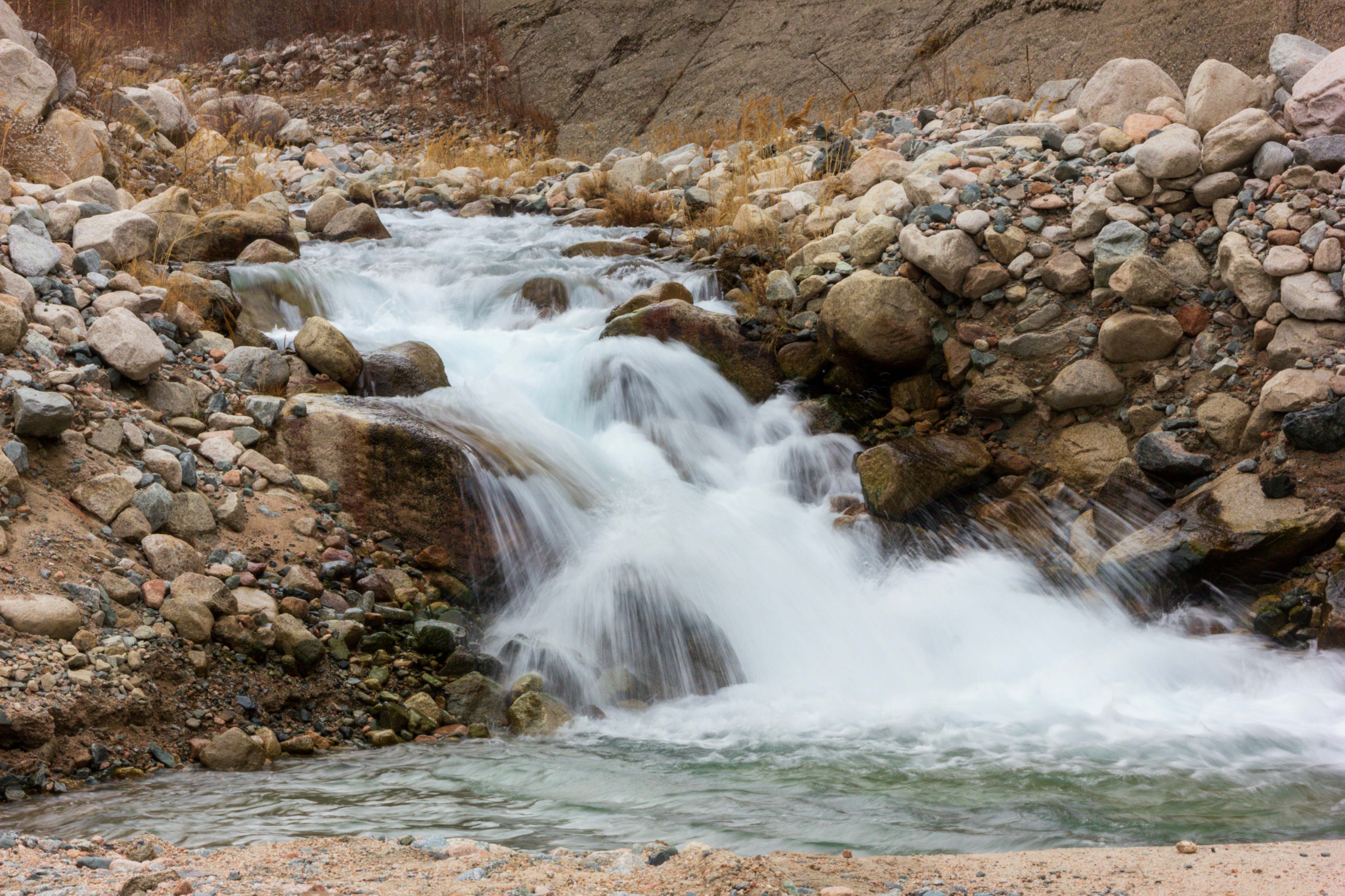 A river flowing through rocks photo – Free Waterfall Image on Unsplash