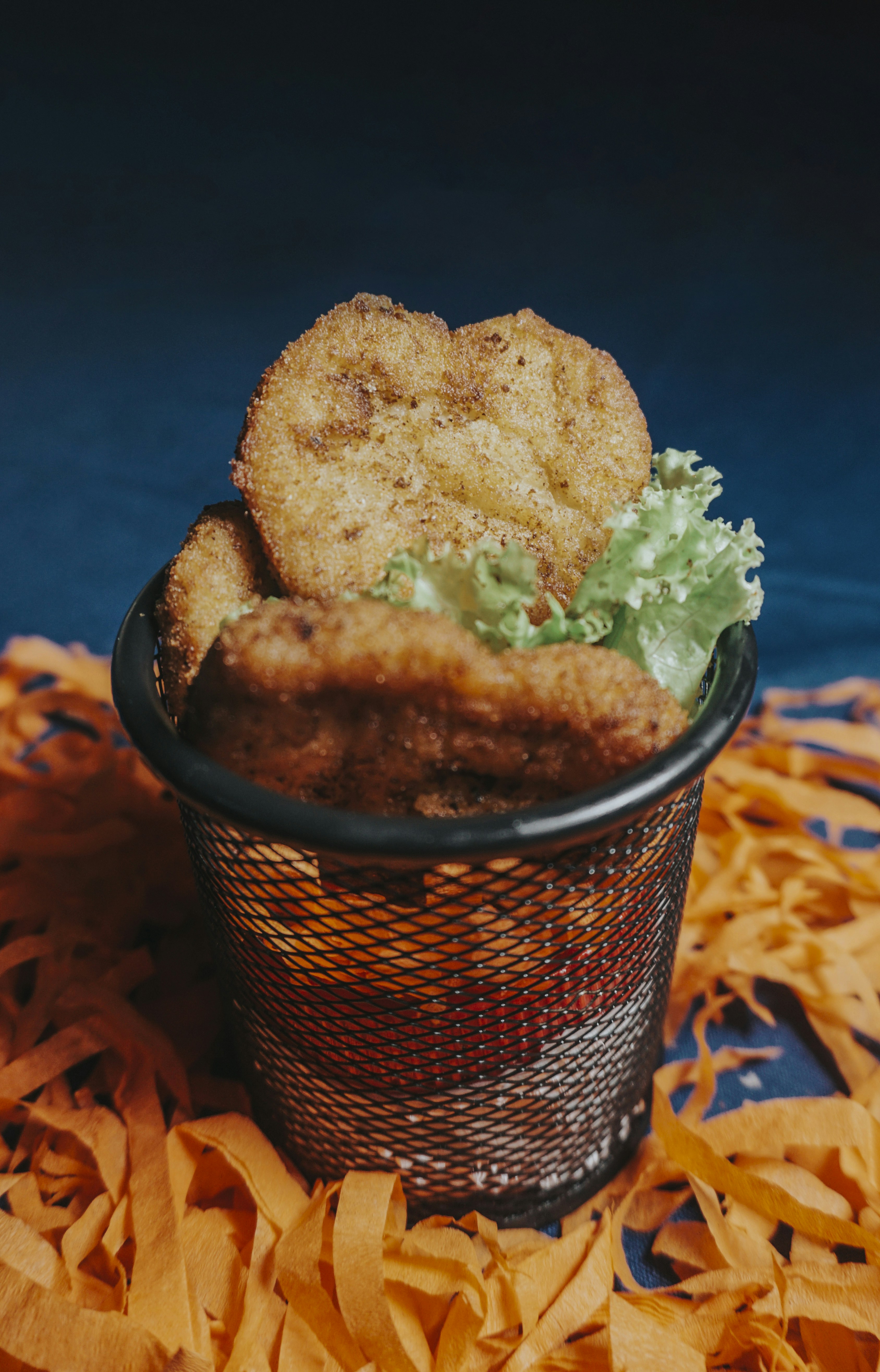 Crispy Crown in a Mesh Basket: Fried Delights on Azure and Amber