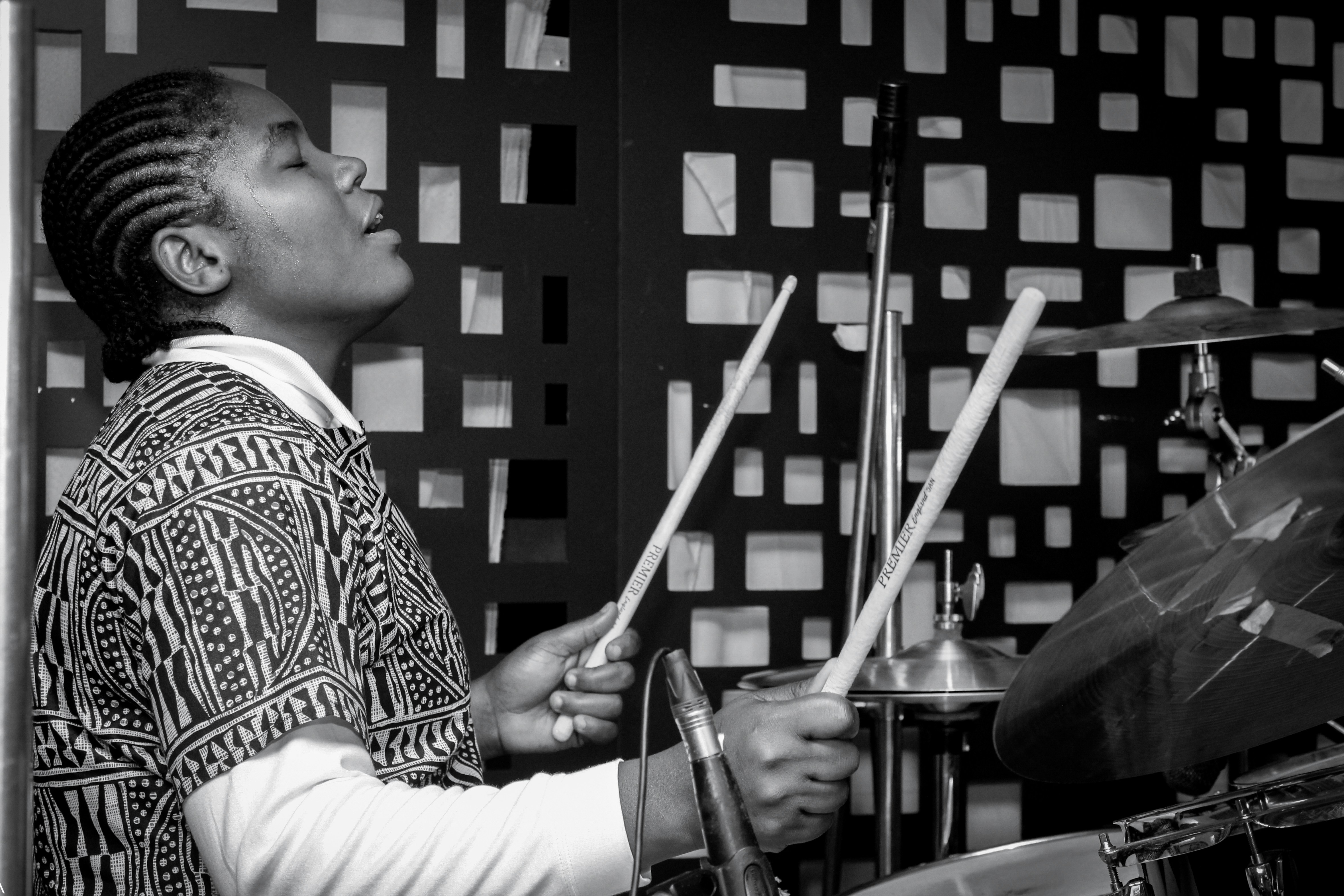 Groove in the Grid: A Drummer's Focus in Monochrome