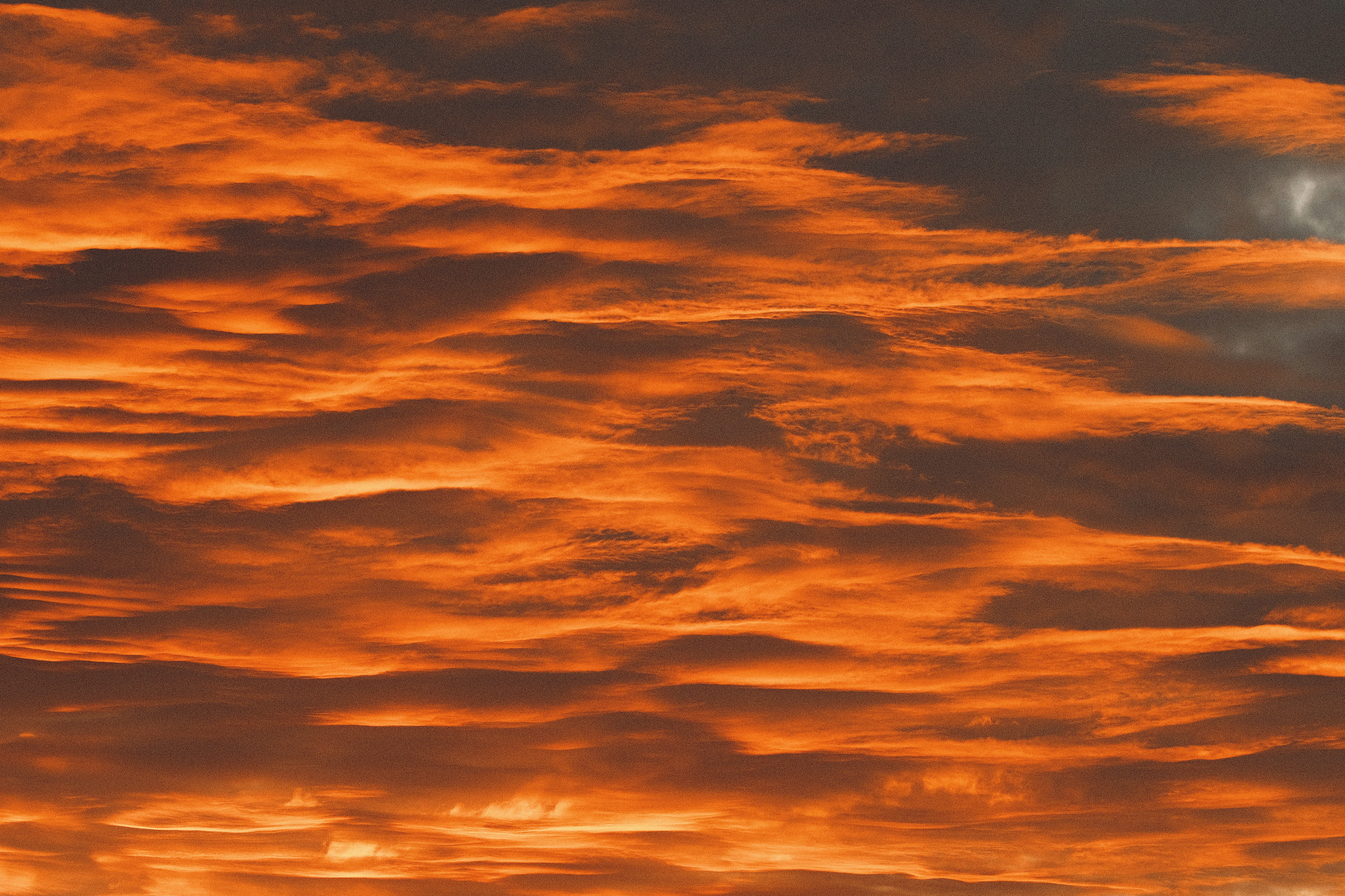 Ember Layers at Dusk: Horizontal Clouds Ablaze in Golden Light