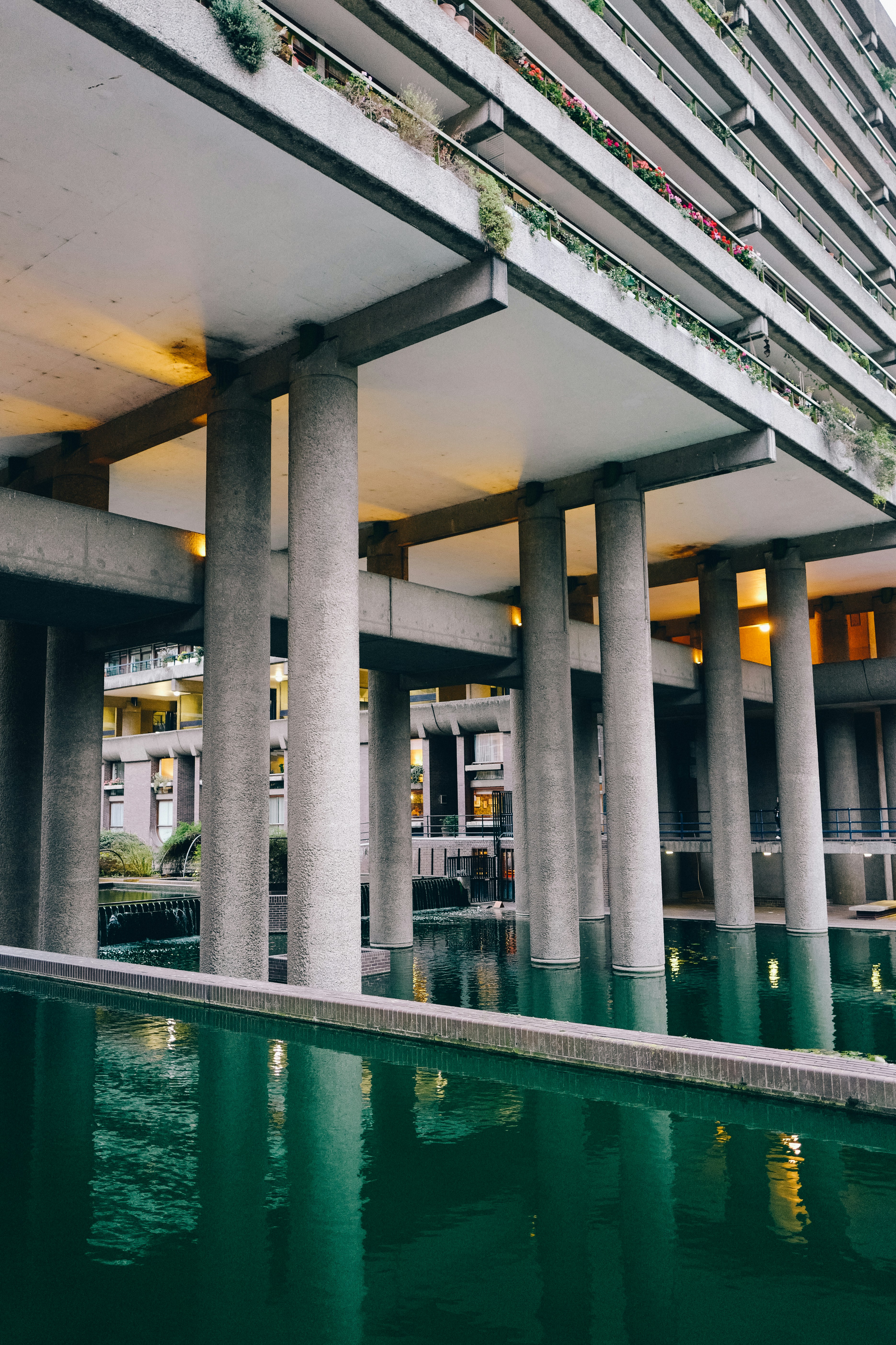 A building with pillars and a pool photo – Free The barbican centre ...