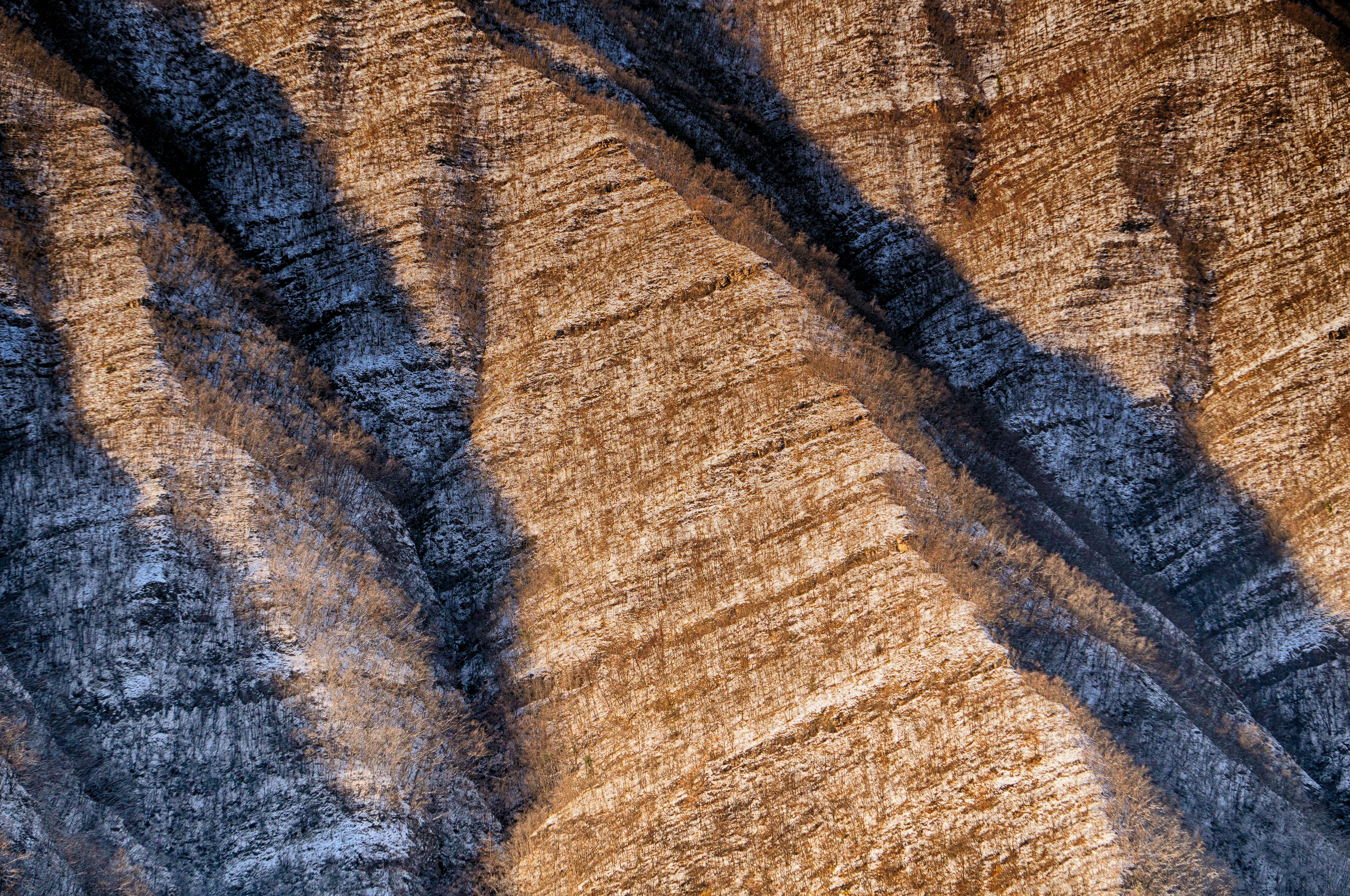Eroded canyon walls display contrasting layers of dark and light sediment.