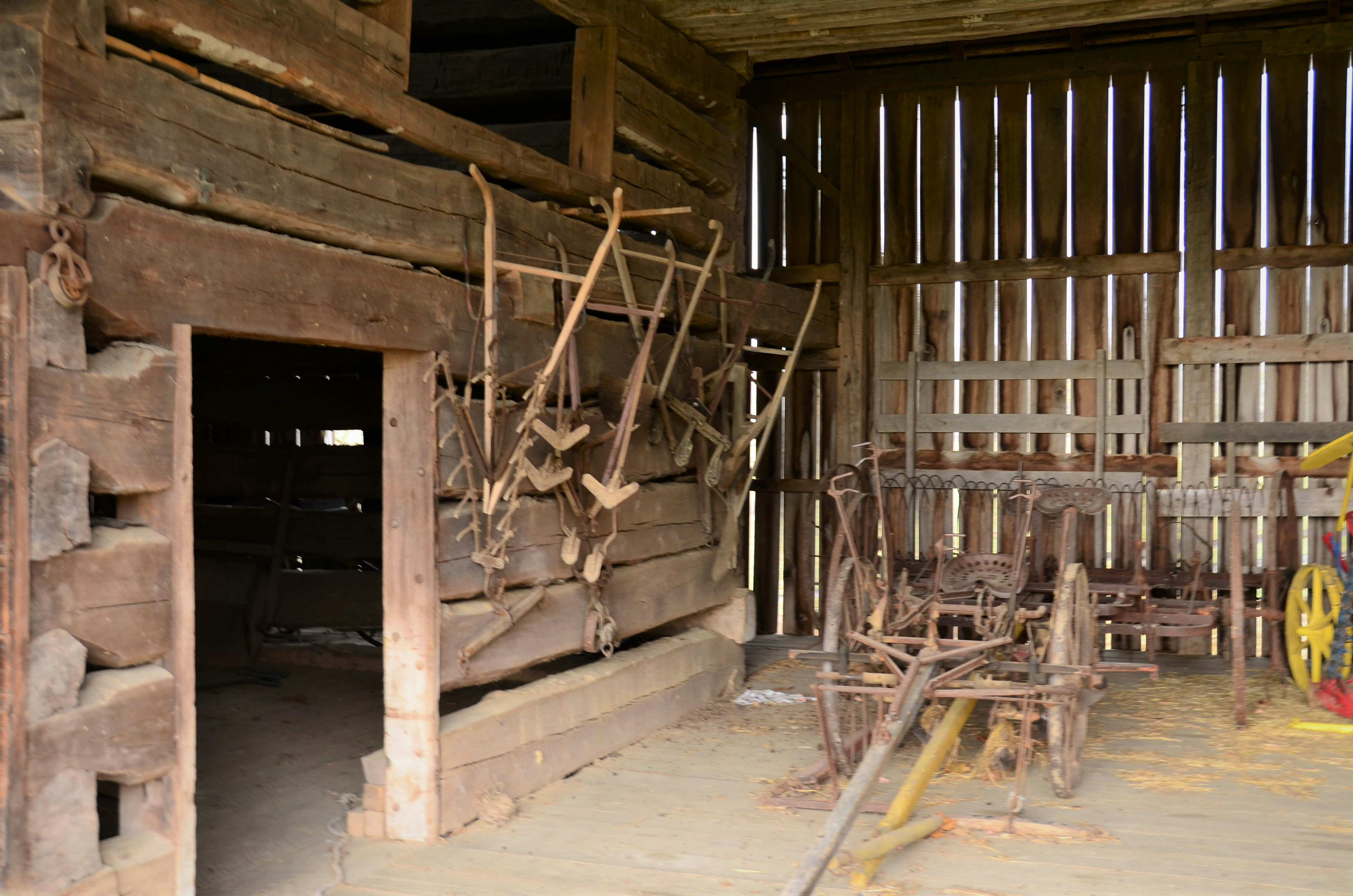 Rusted Light: A Barn’s Quiet Arsenal of Timeworn Implements