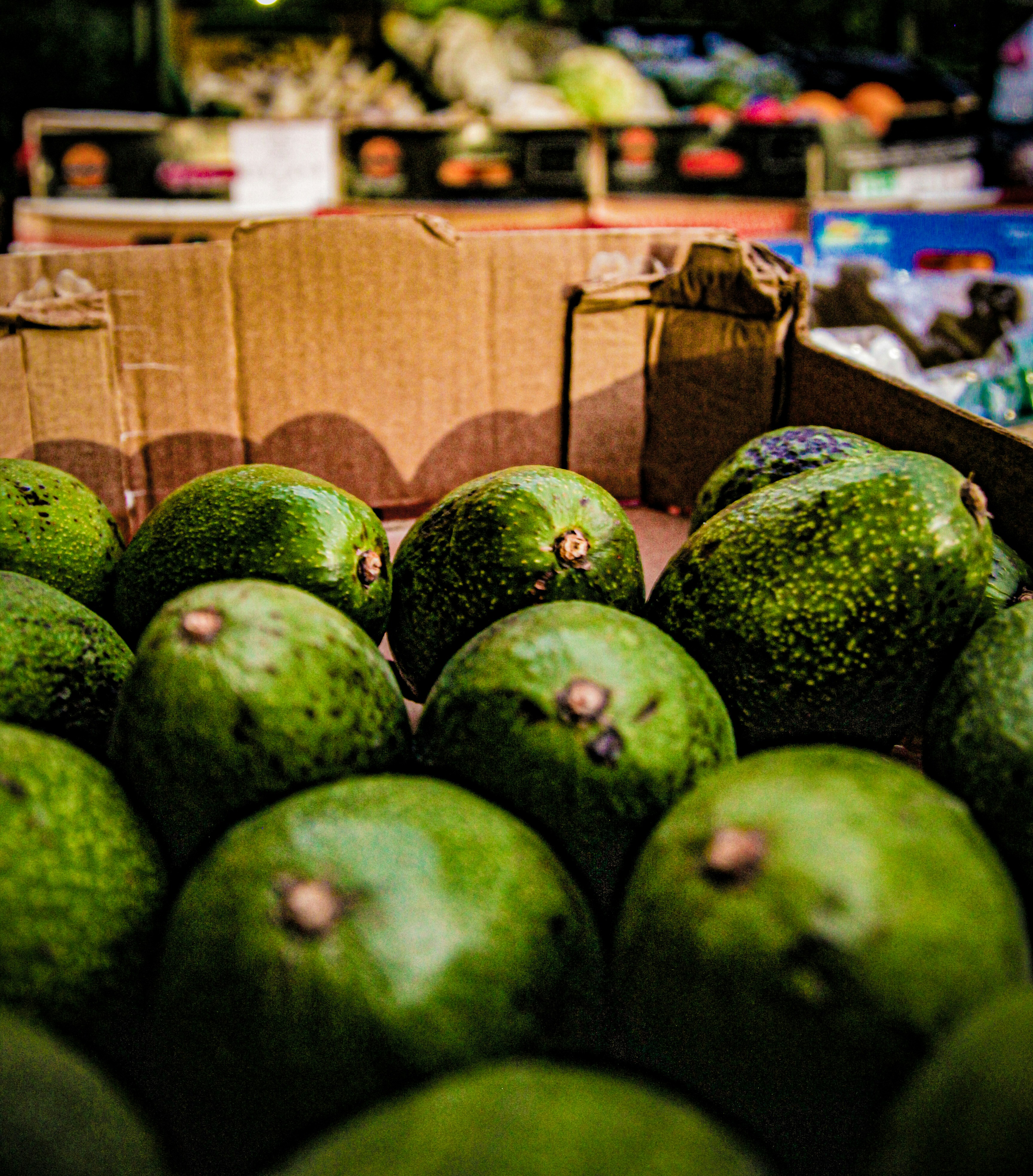 Market Greens: Avocados Reigning Over a Busy Produce Stand