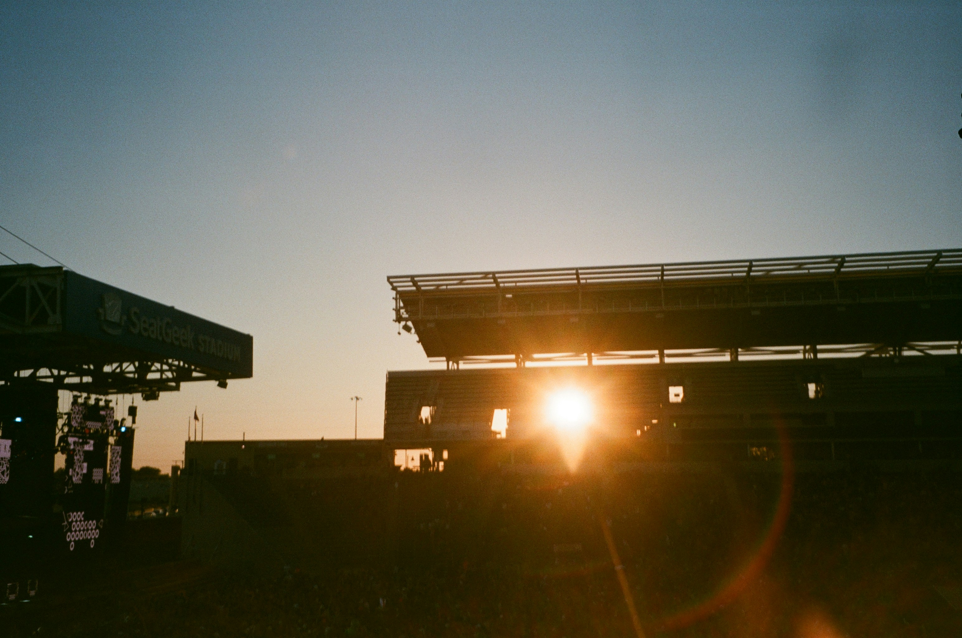 Sunburst Over a Silent Arena: Sunset Stage in Shadow