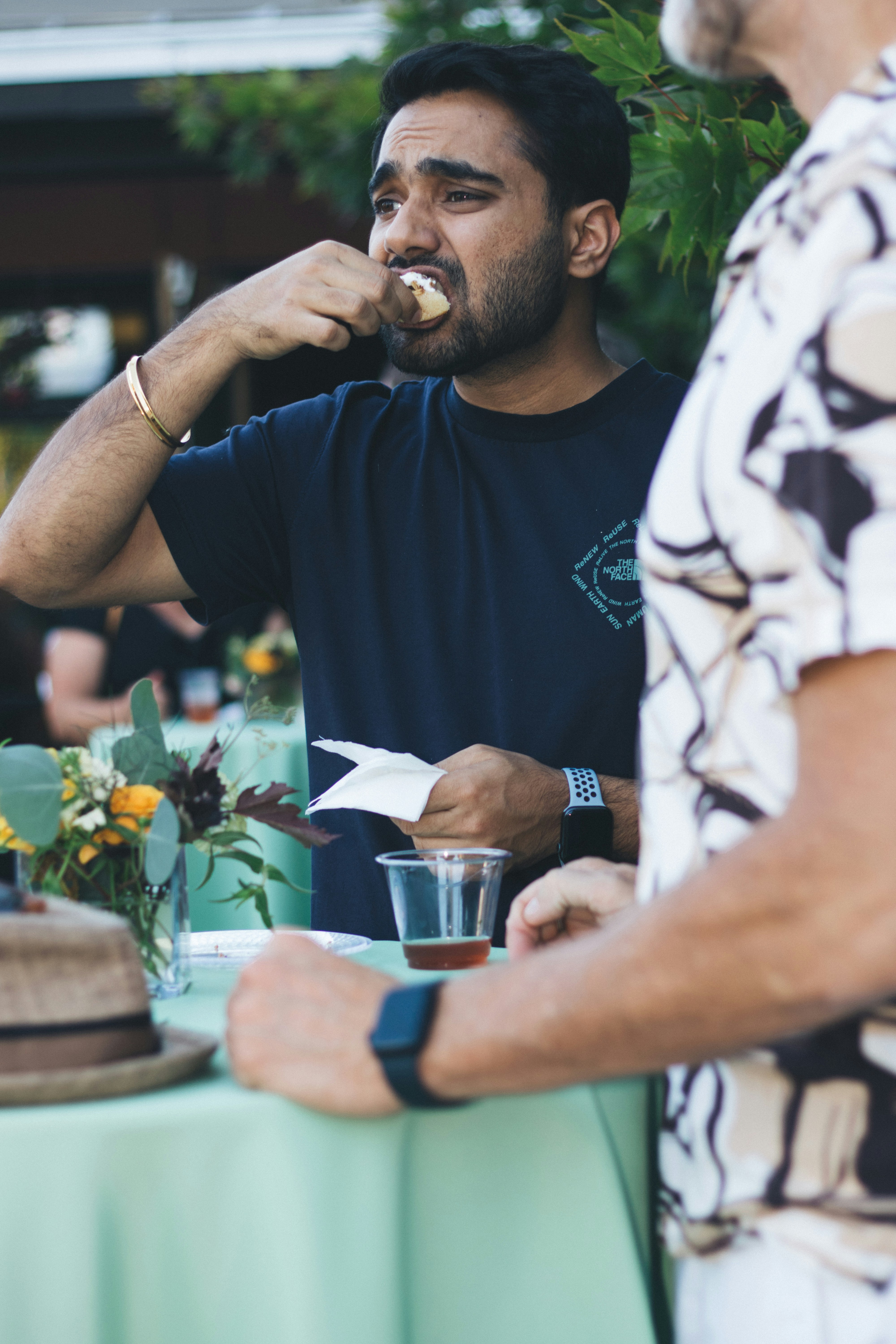 Mid-Meal Moment: A Handsome Bite and Shared Laughter