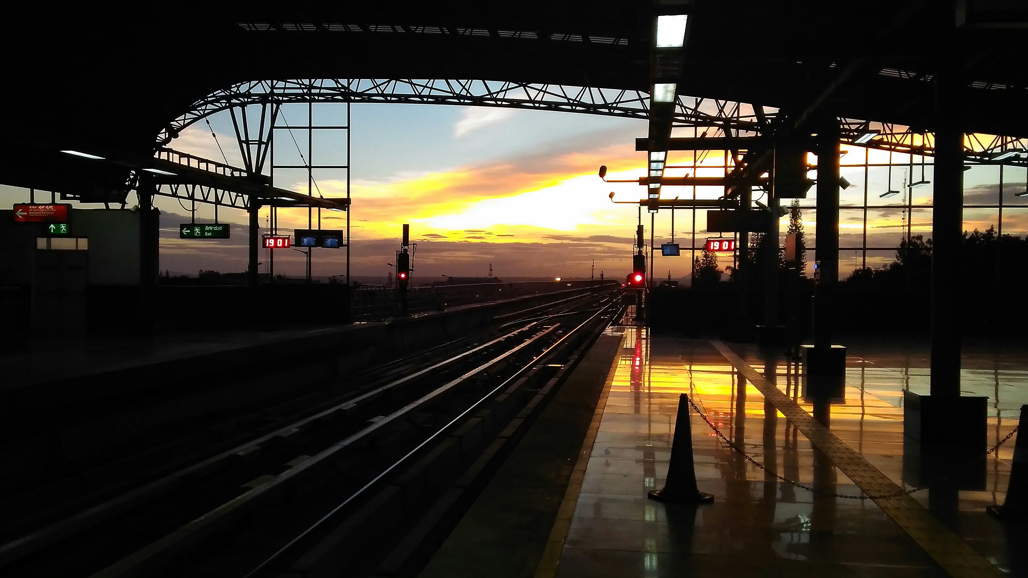 Sunset Over Rails: Distant Horizon Through a Rain-Slick Platform