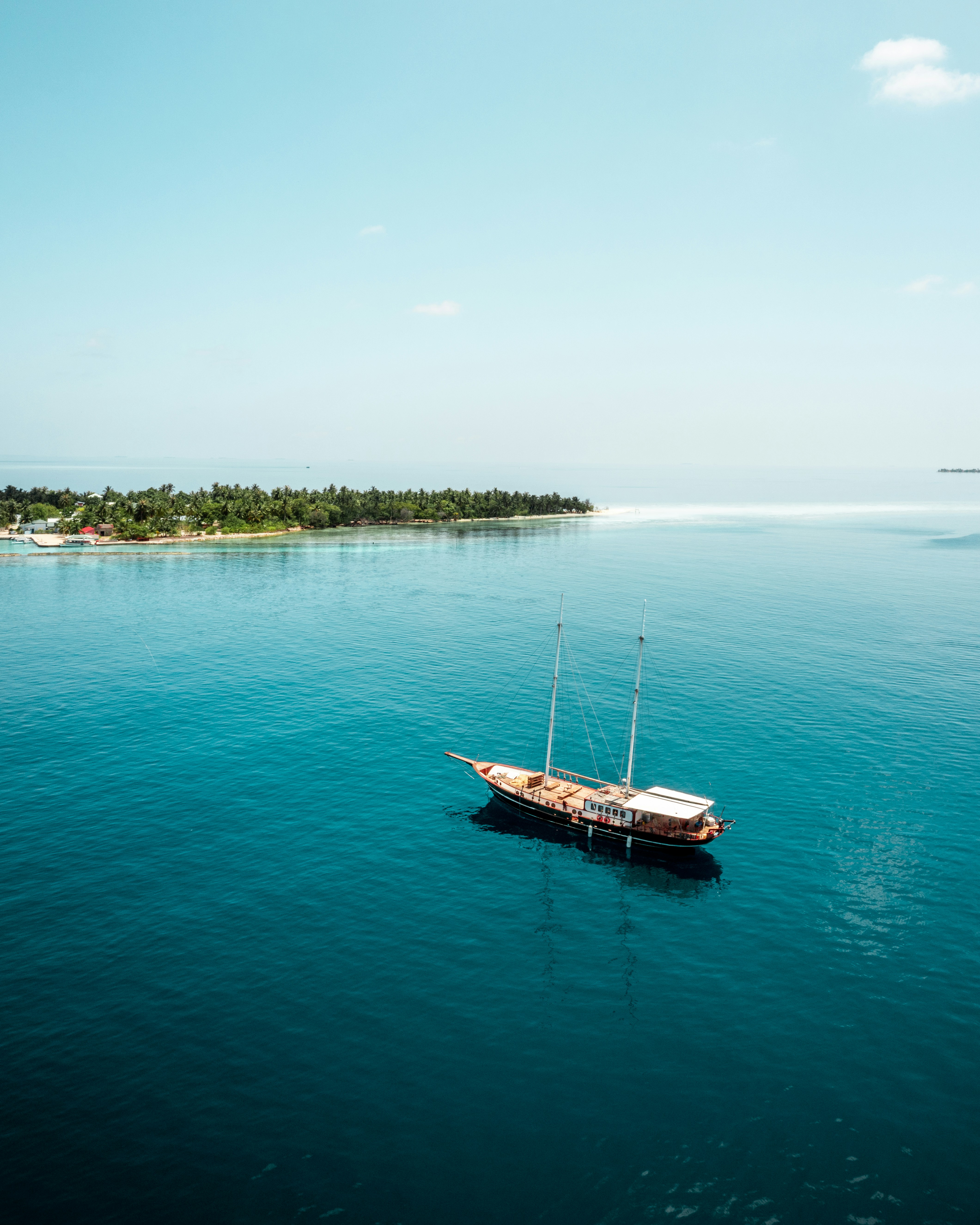 Sailing Vessel Drifts on Tropical Azure