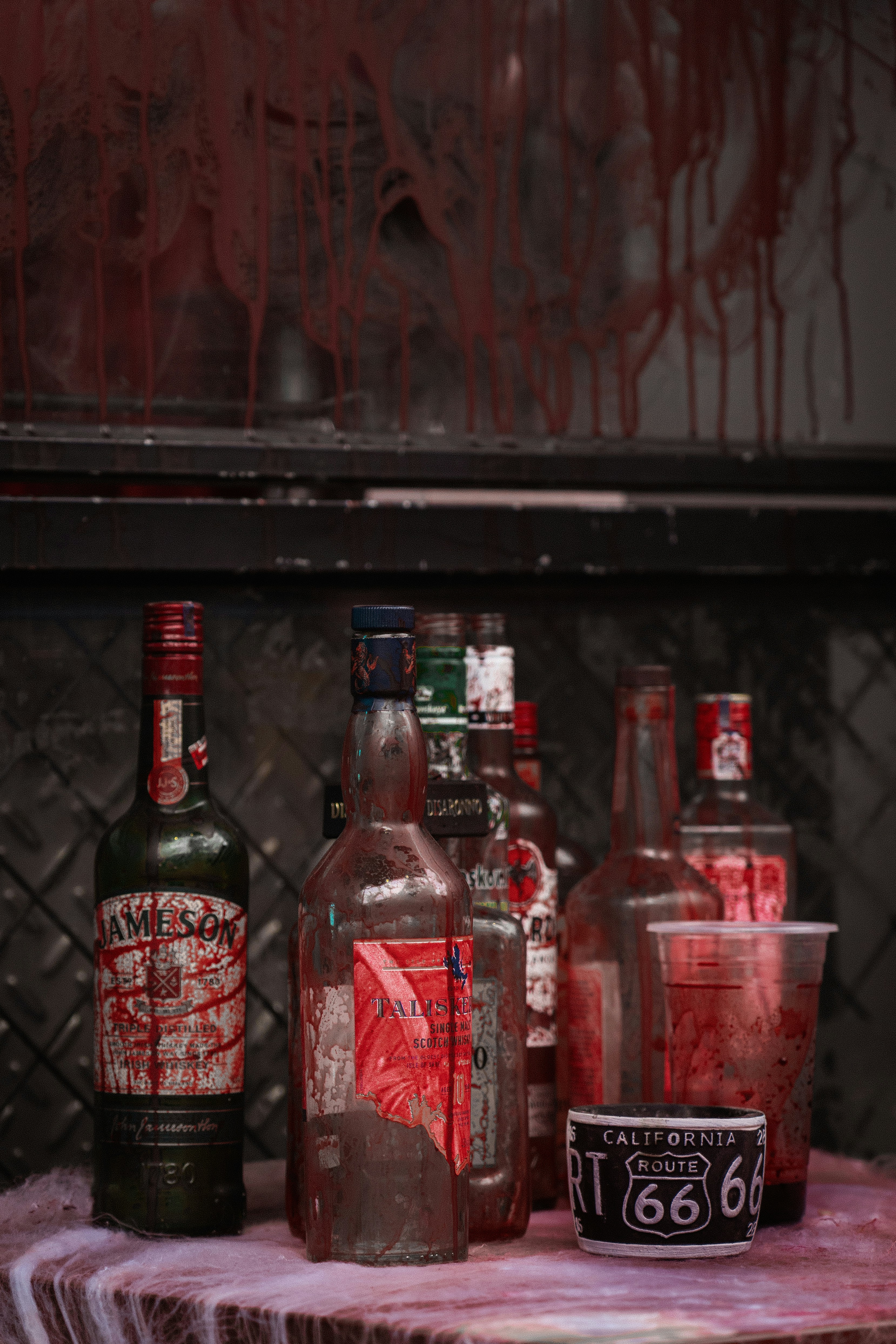 Scarlet Drips: A Moody Still-Life of Bottles and Route 66