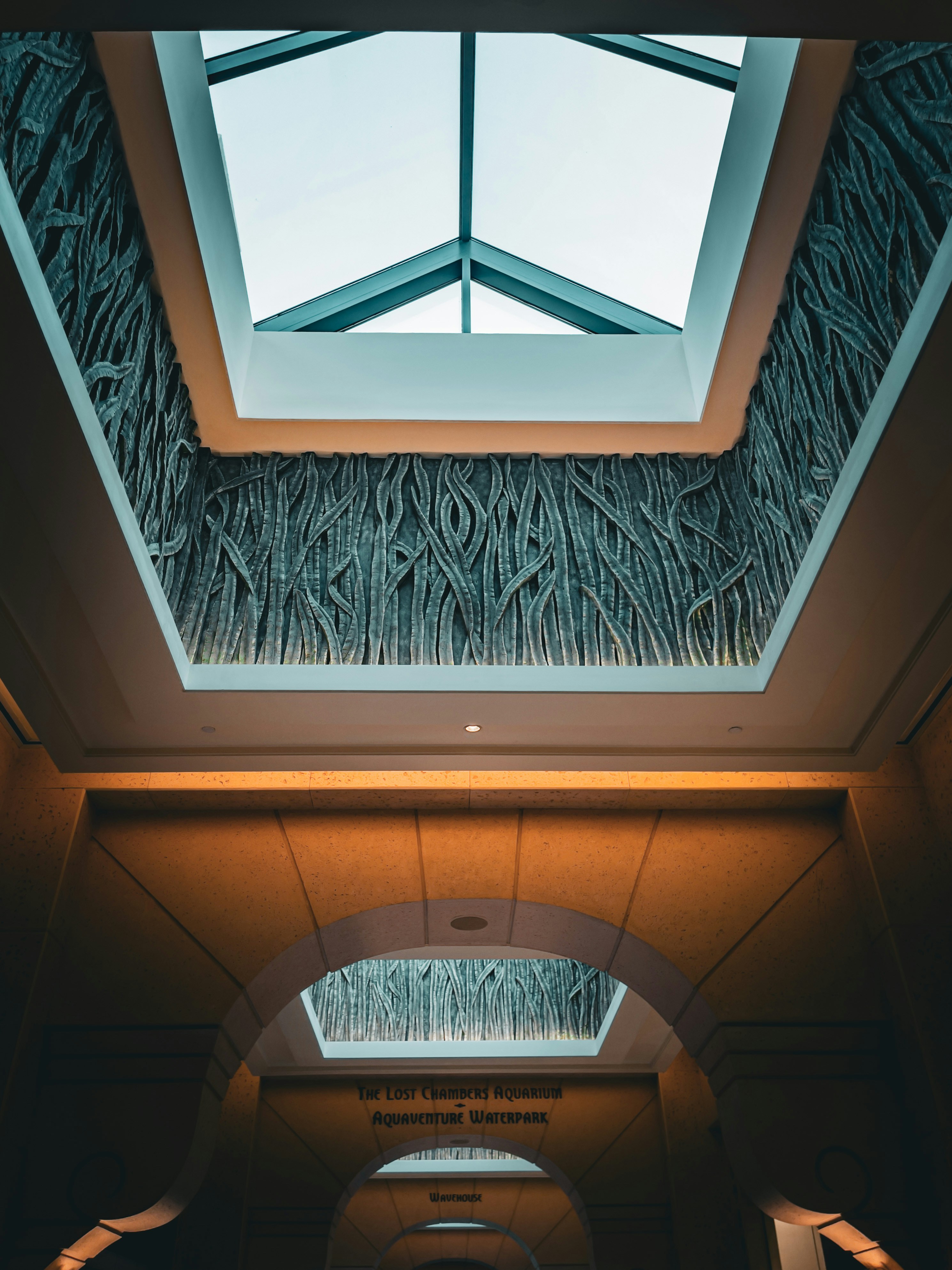 Skylight Atrium: Archways Framed by Ribboned Walls