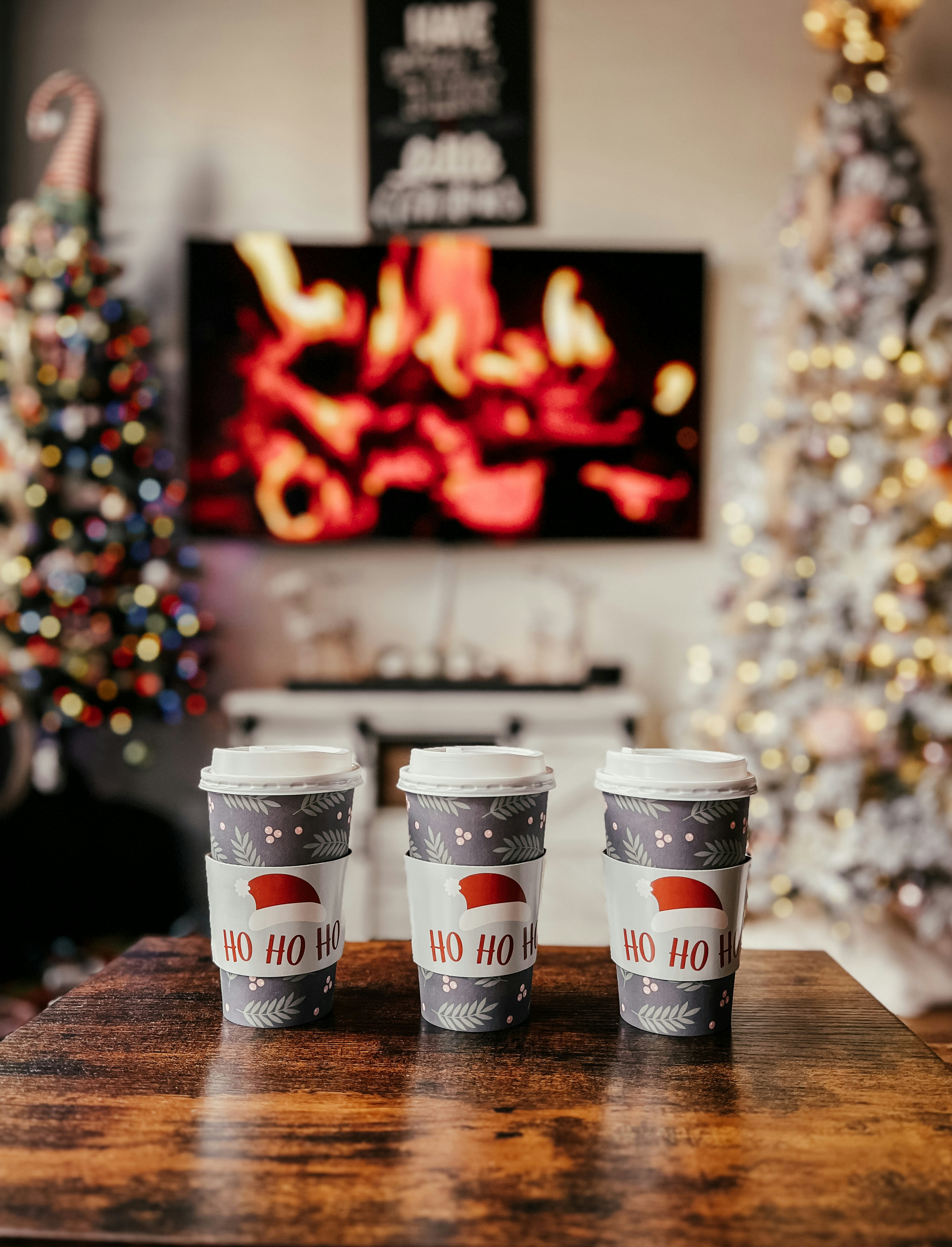 Trio of Festive Coffee Cups Anchored on a Warm Christmas Table