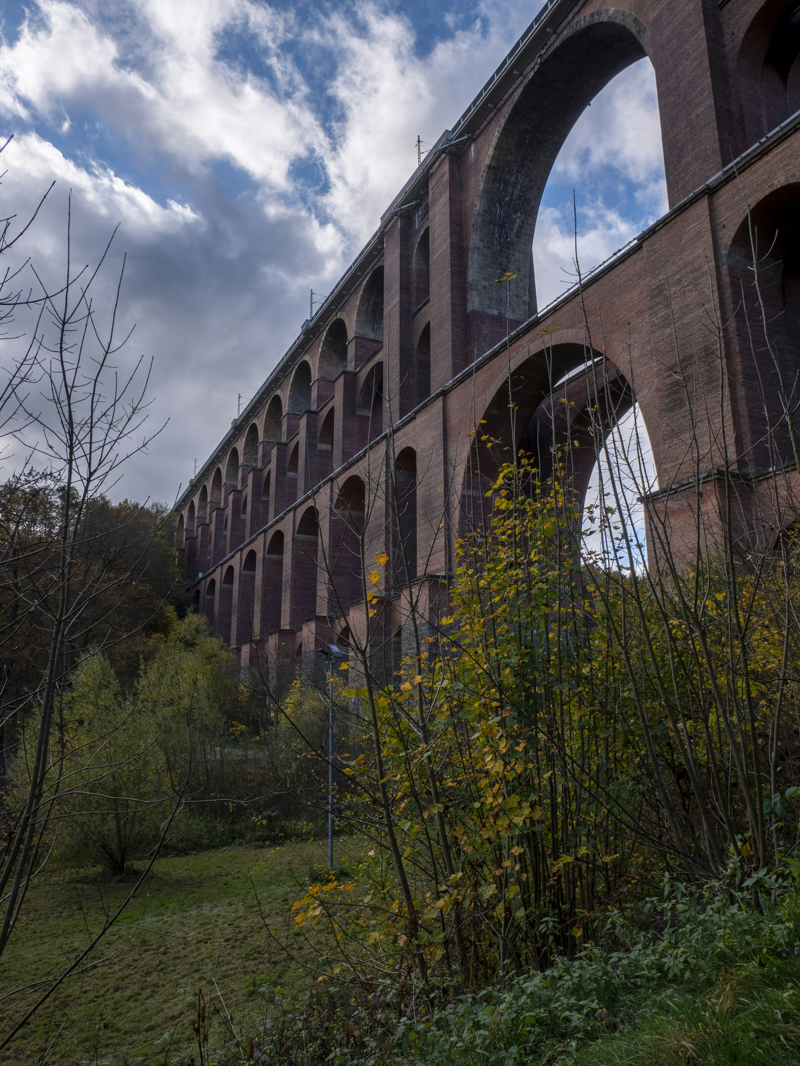 Brick Arches of the Overpass: A Riverside Monolith at Dusk