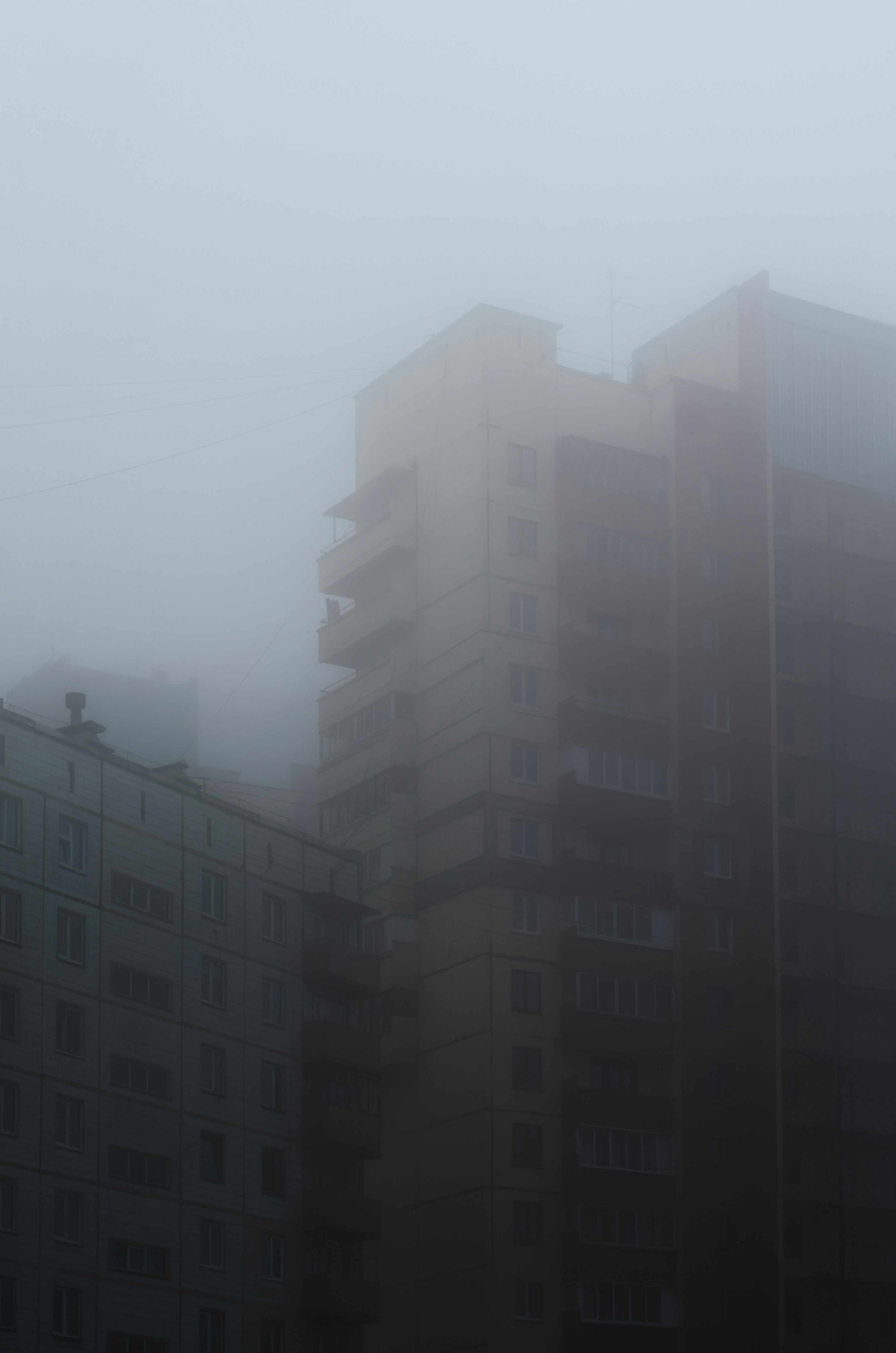 a group of buildings with fog