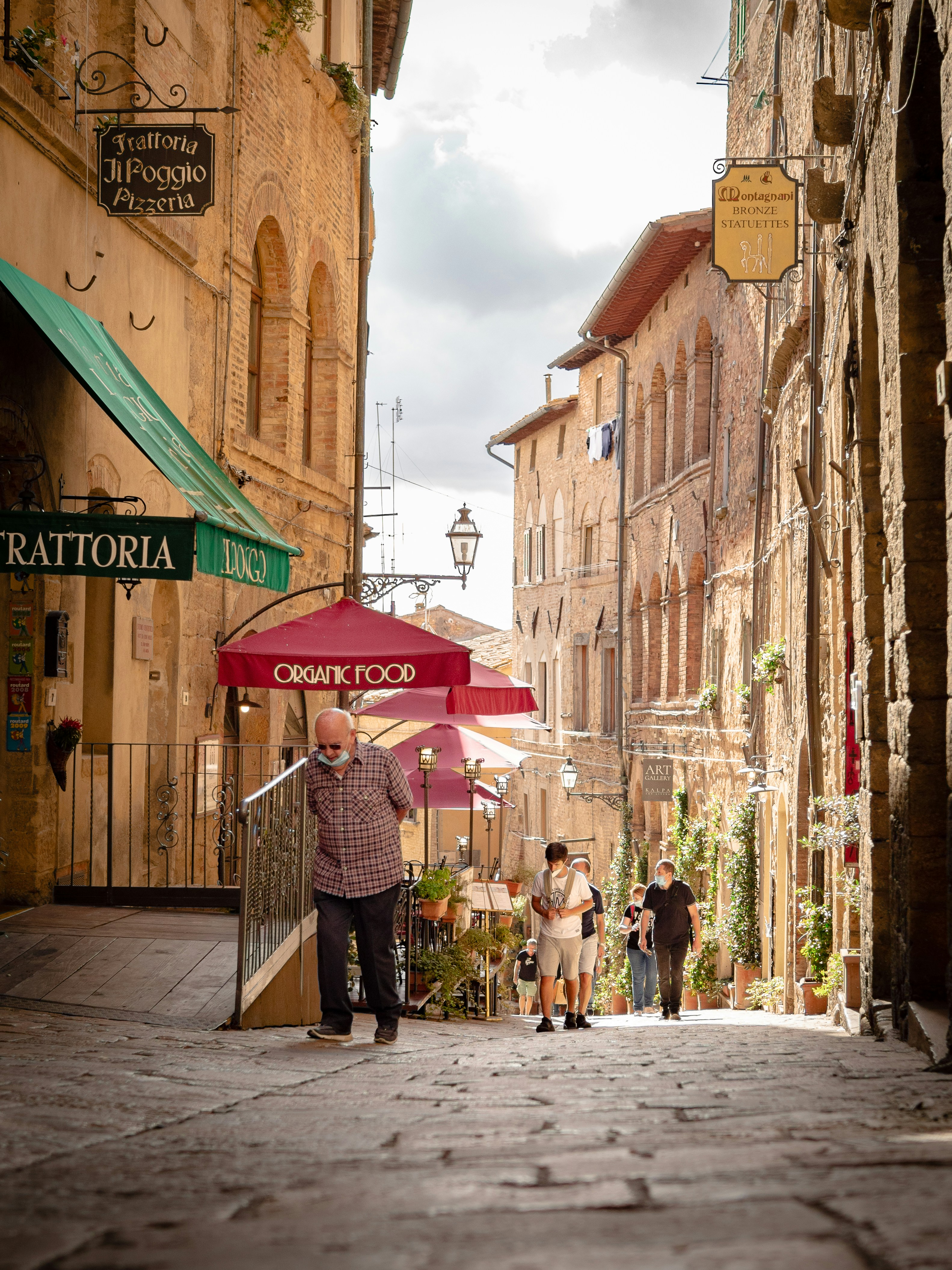 Sunlit Italian Street Café Between Ancient Walls