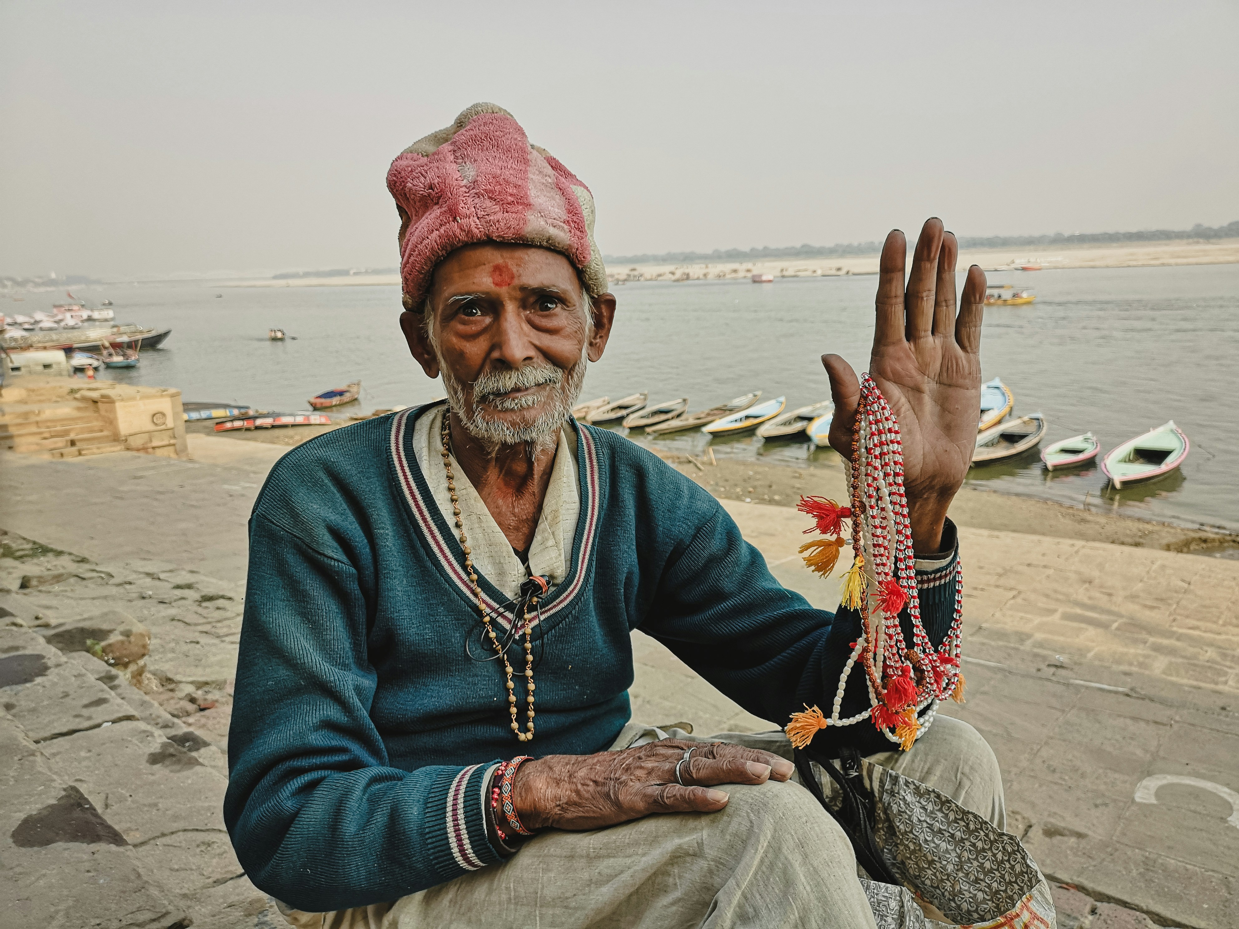 Hands of Time: A Hindu elder offers a prayerful greeting beside the river
