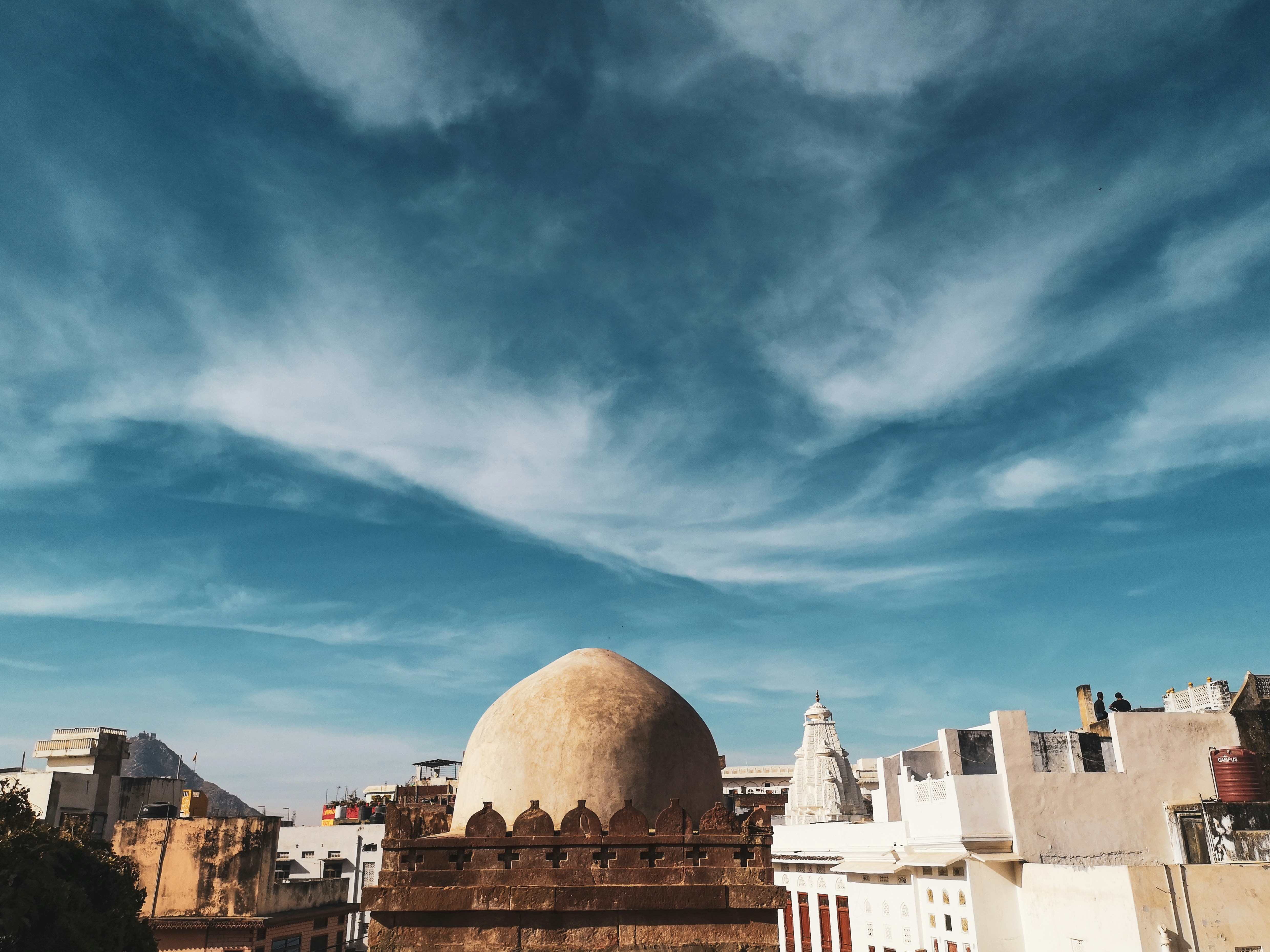 Dome Over the Rooftops: A Sunlit Cityscape Under Expansive Skies