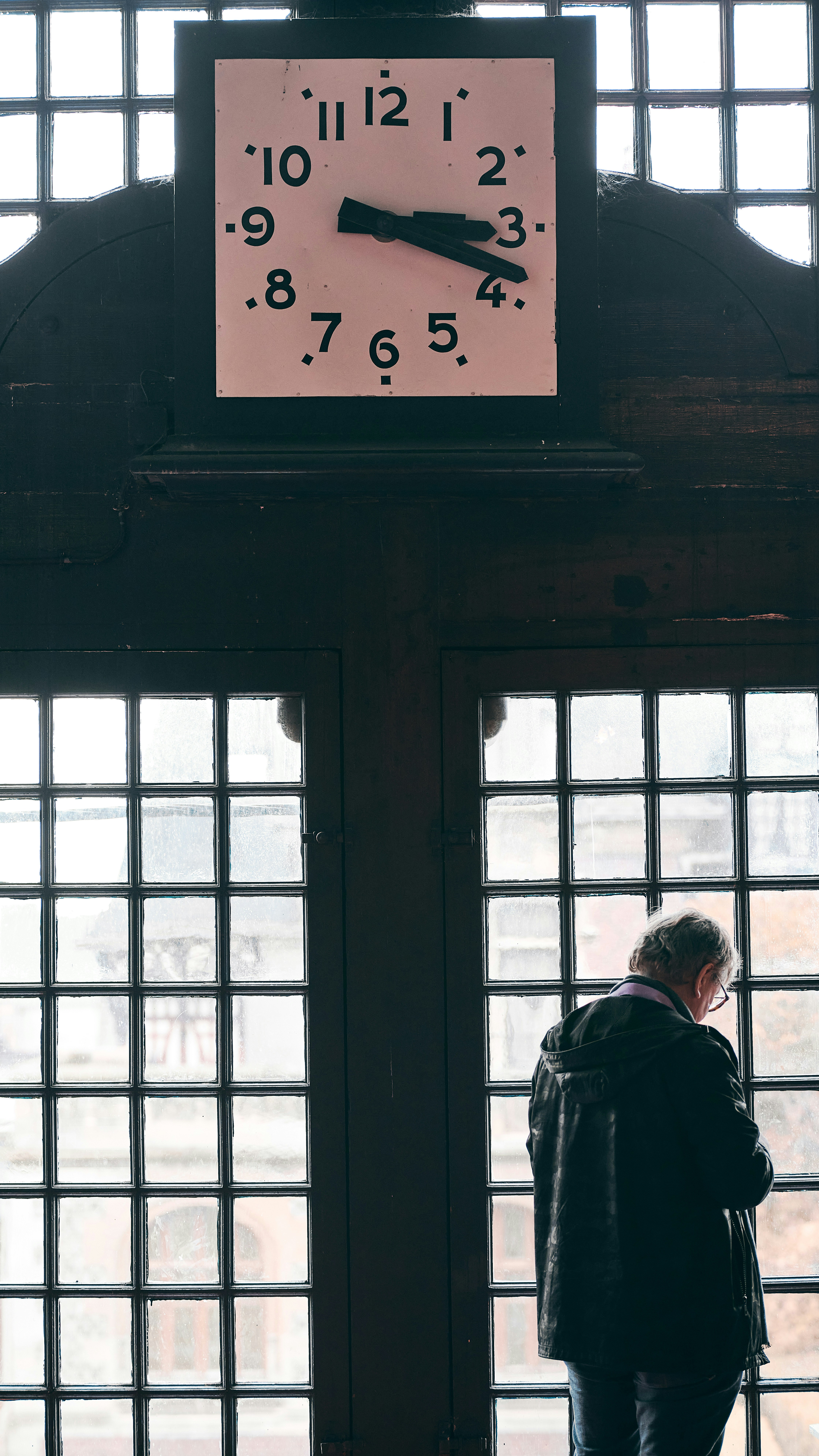 Clocktower Quiet: A Man in the Atrium beneath Time
