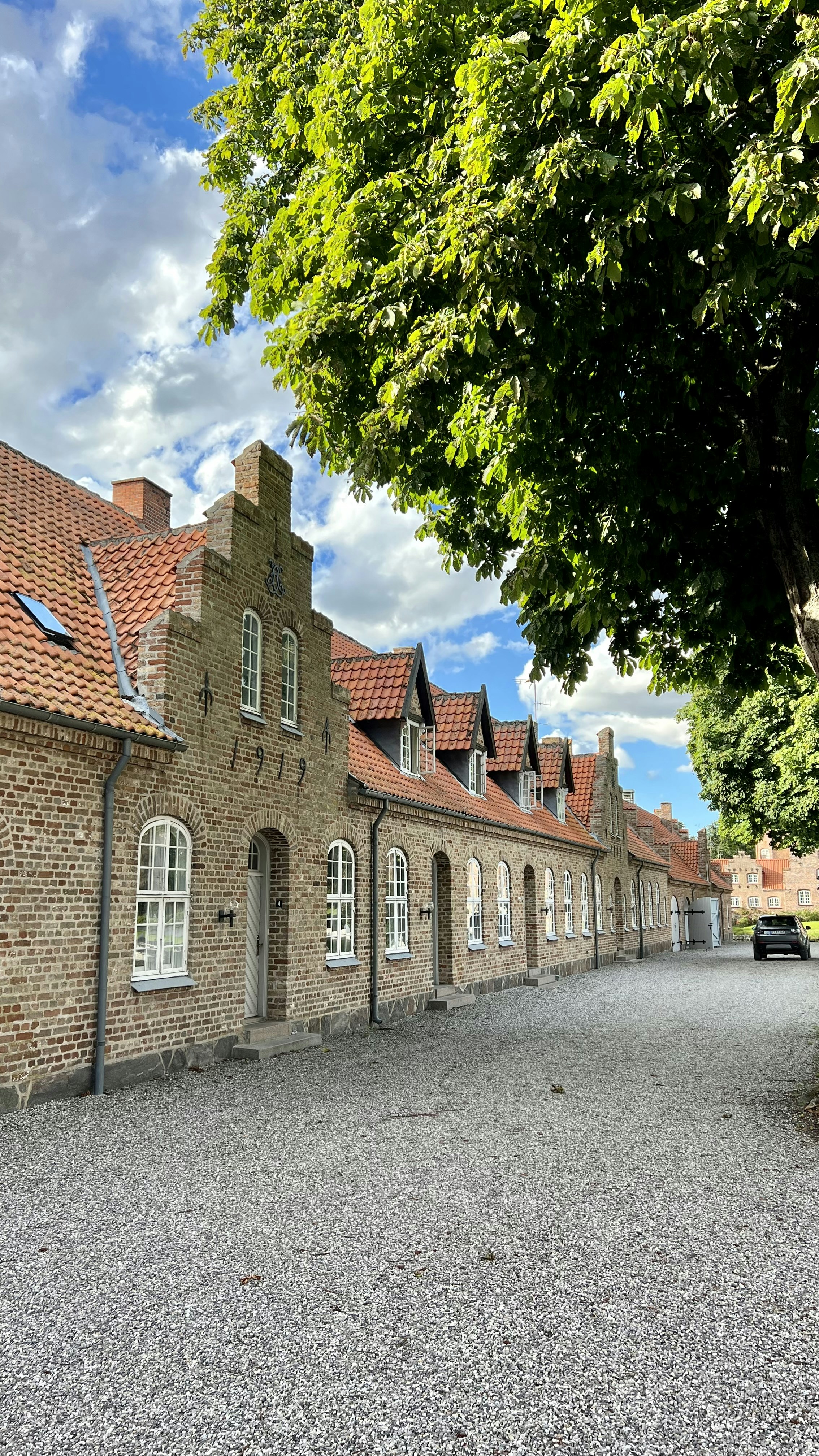 A brick building with a tree in front of it photo – Free Grenaa Image ...