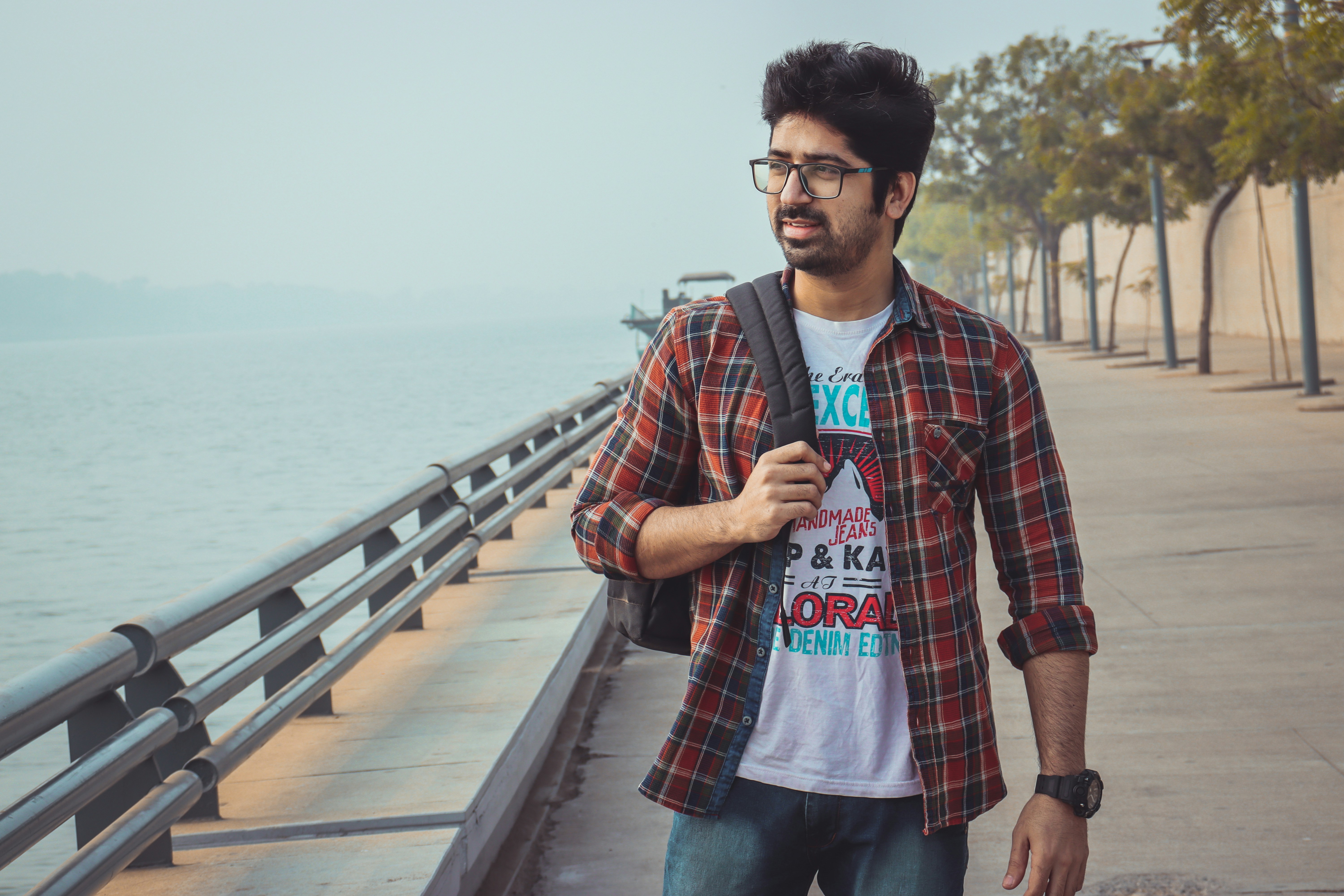 A man standing on a bridge photo – Free Indian boy Image on Unsplash