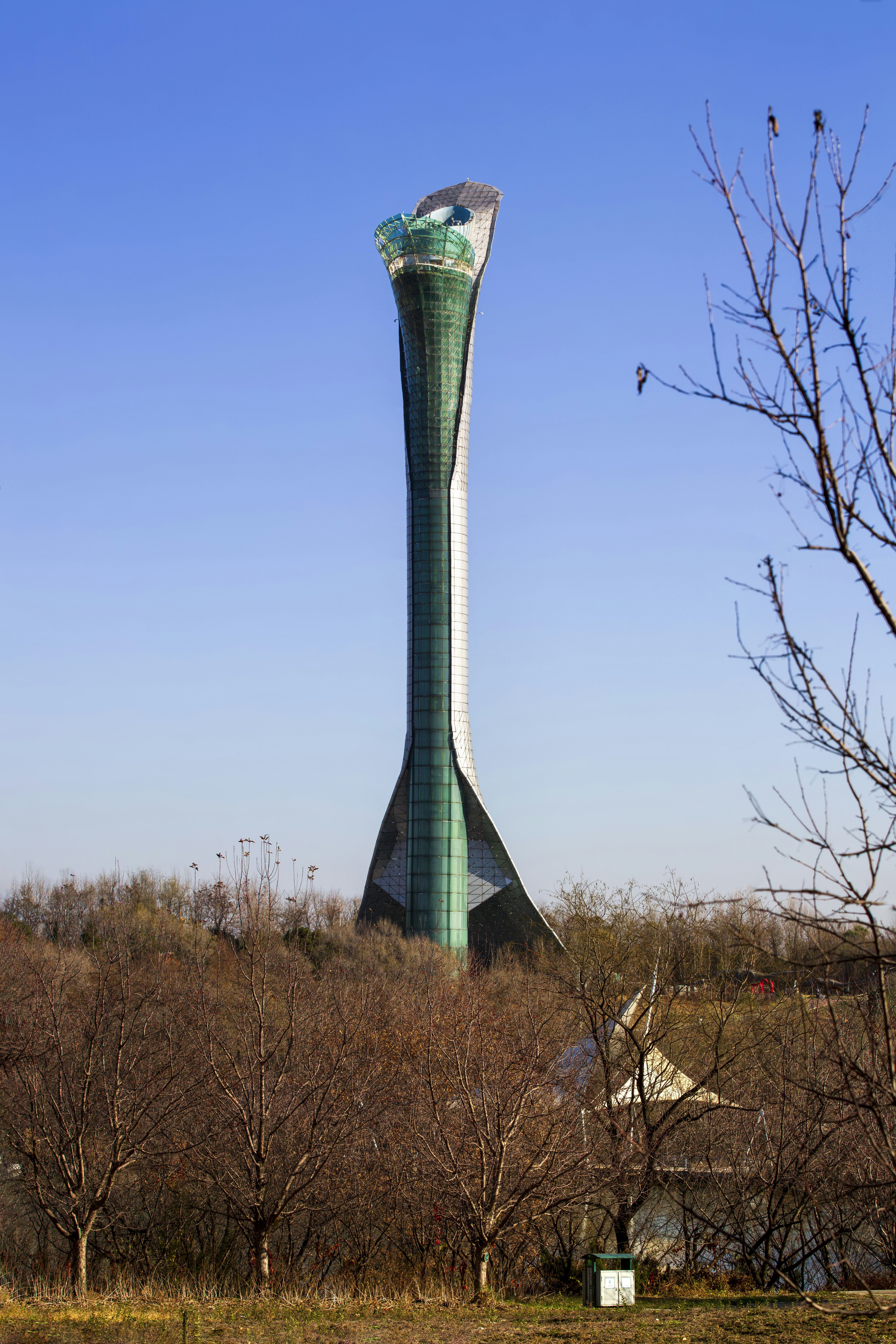 A tall tower with trees around it photo – Free Architecture Image on ...