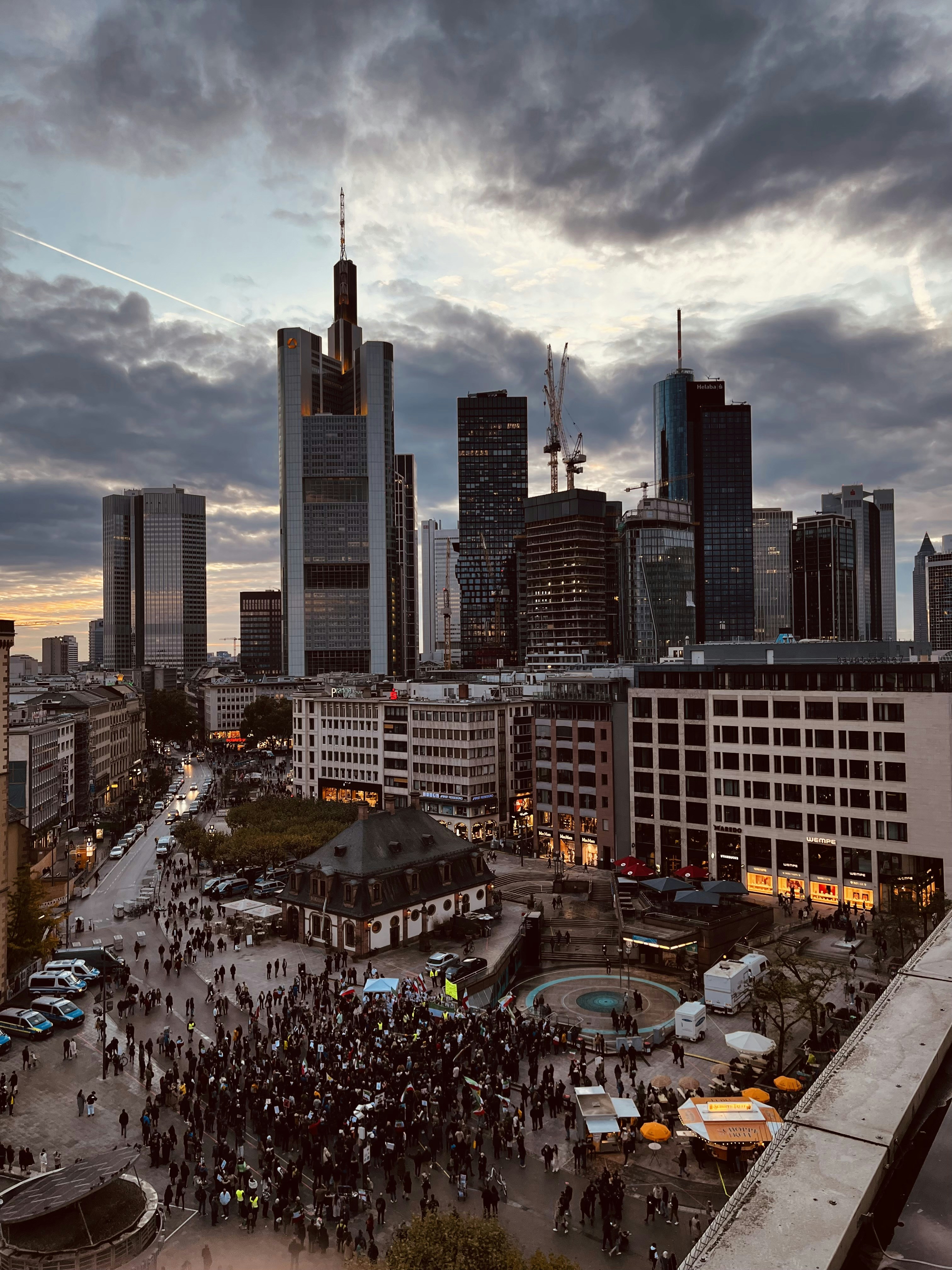Dusk Convergence: Crowds Beneath a Glassy Skyline